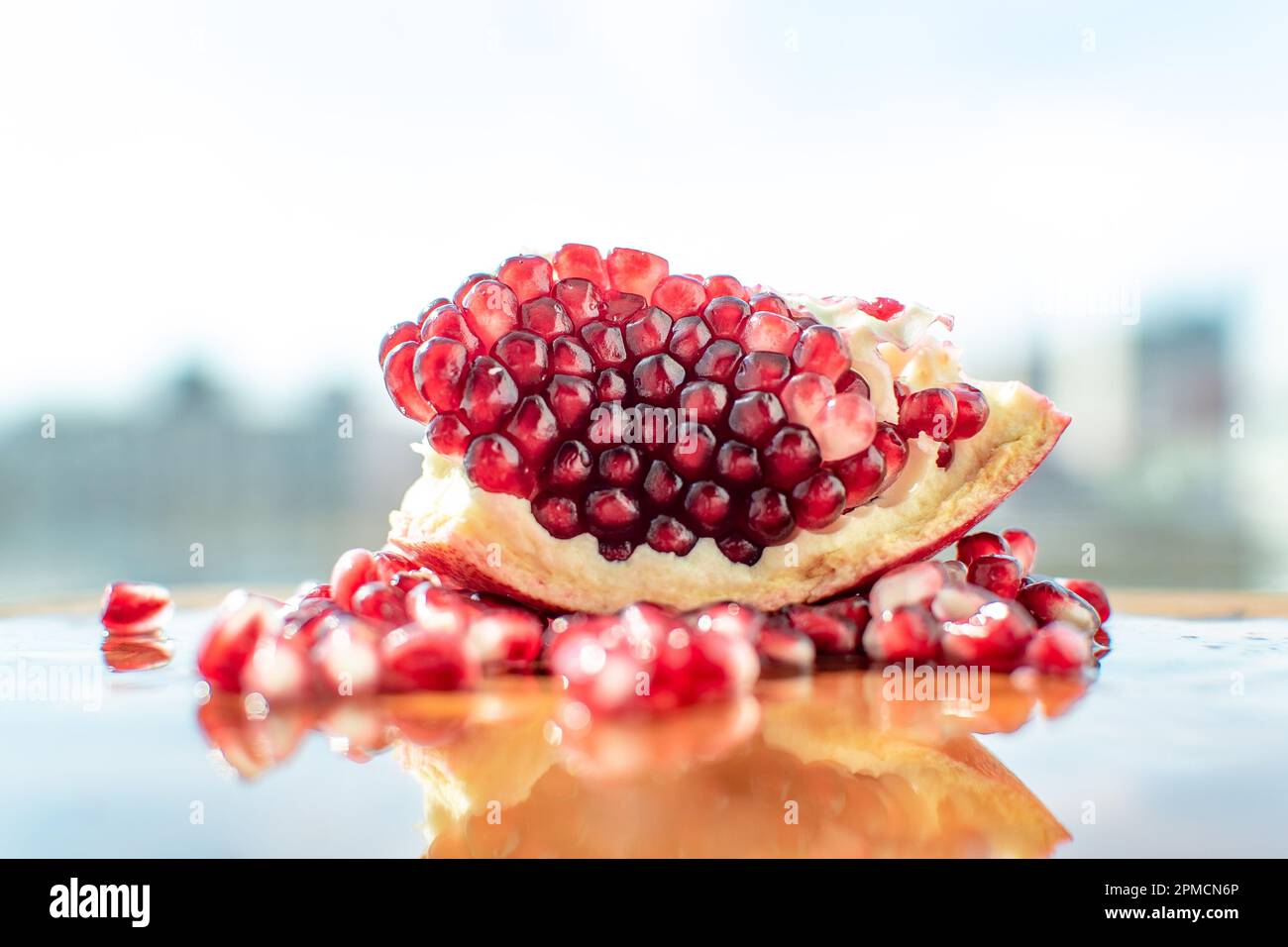 Close-up of pomegranate with its vibrant red color. The small pods are ...