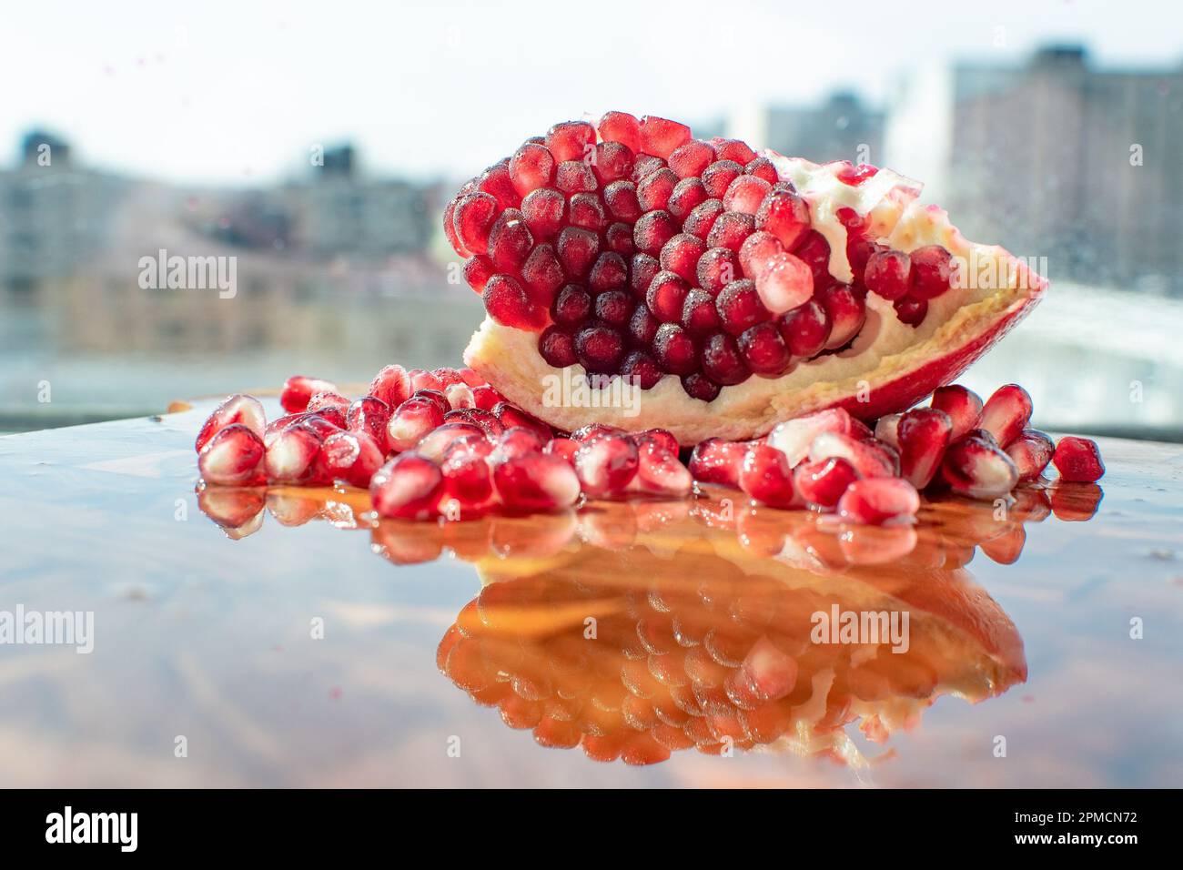 Close-up of pomegranate with its vibrant red color. The small pods are ...