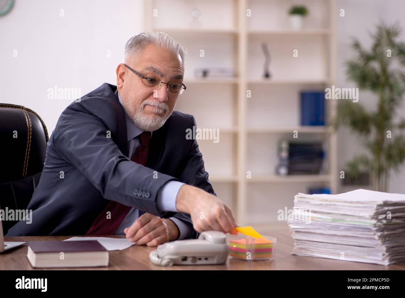 Old boss working in the office Stock Photo - Alamy