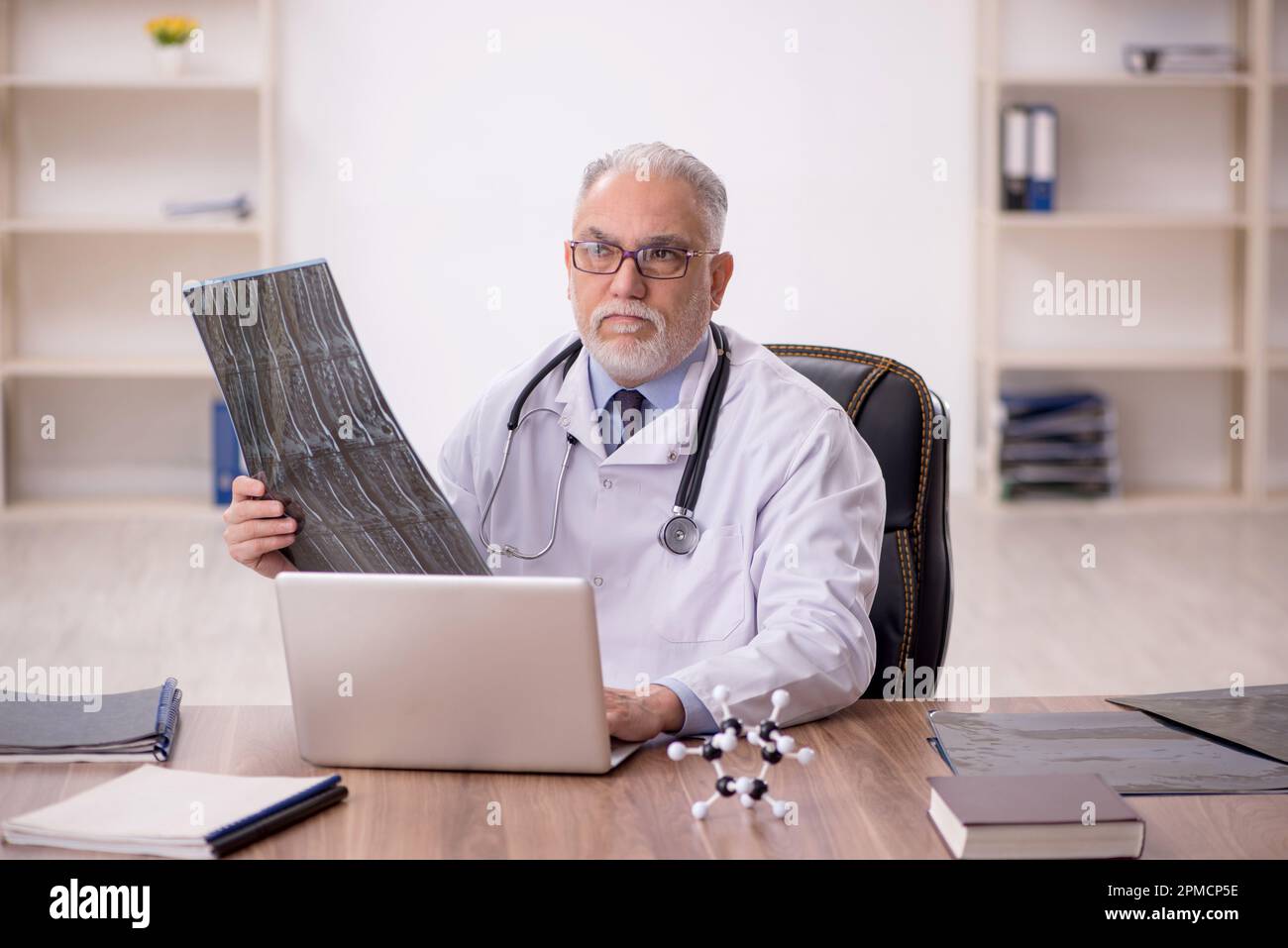 Old male doctor radiologist working at the hospital Stock Photo - Alamy