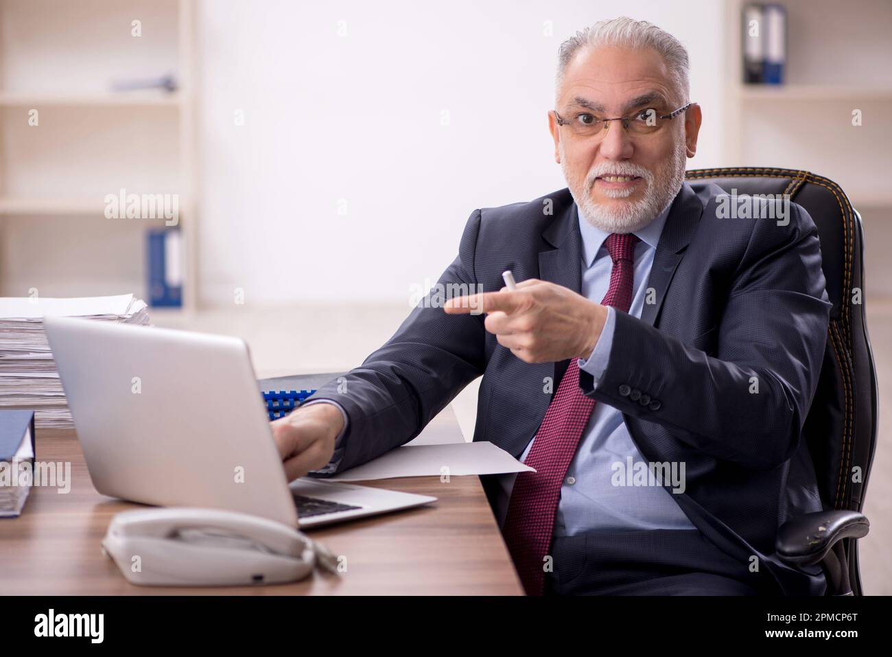 Old boss working in the office Stock Photo - Alamy