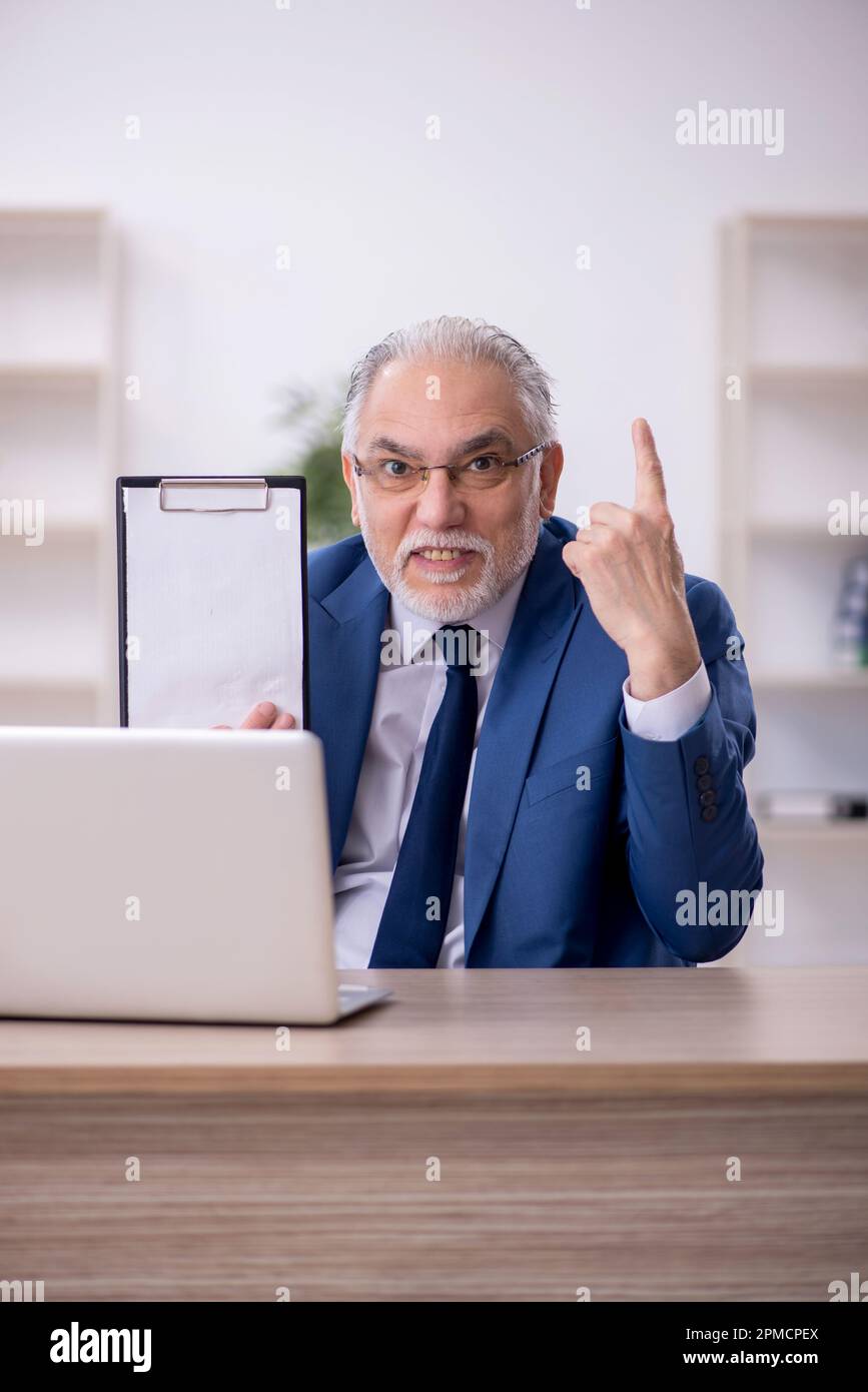 Old boss working in the office Stock Photo - Alamy