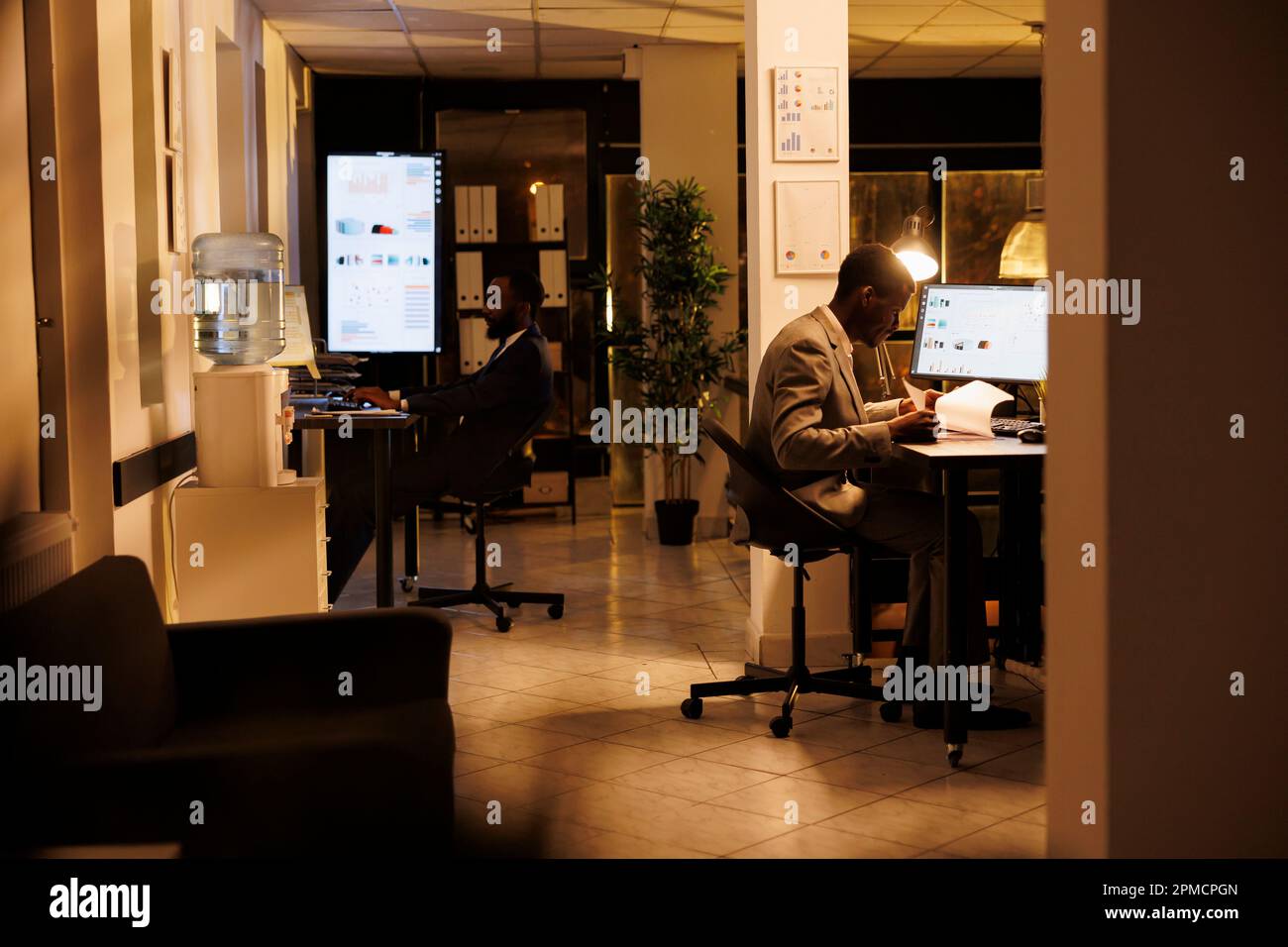 Corporate employee working overtime at marketing strategy, analyzing ...