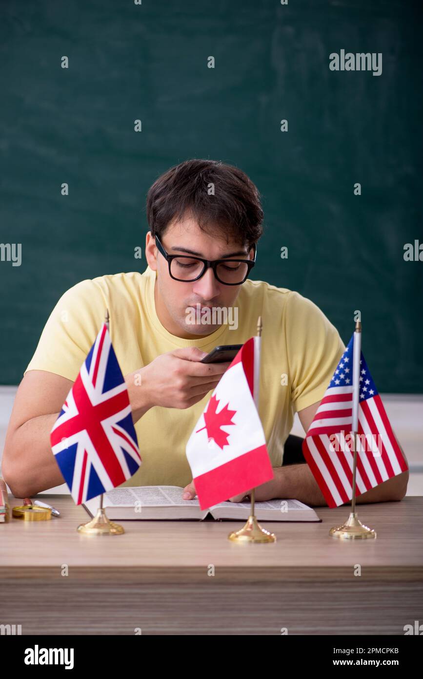 Young English language teacher sitting in the classroom Stock Photo - Alamy
