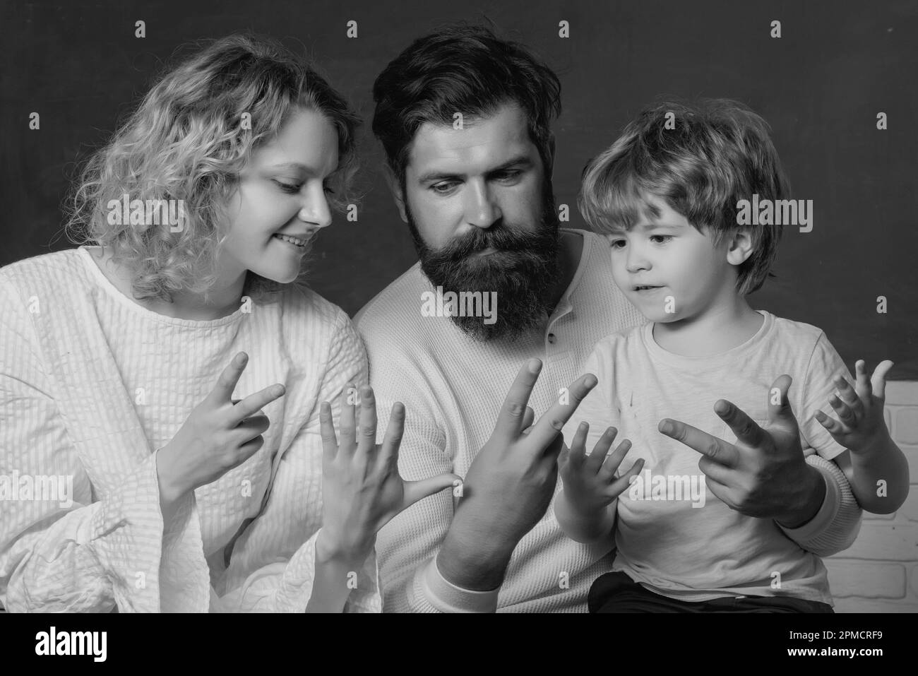 Parents encouraging their little son before the first day of school ...