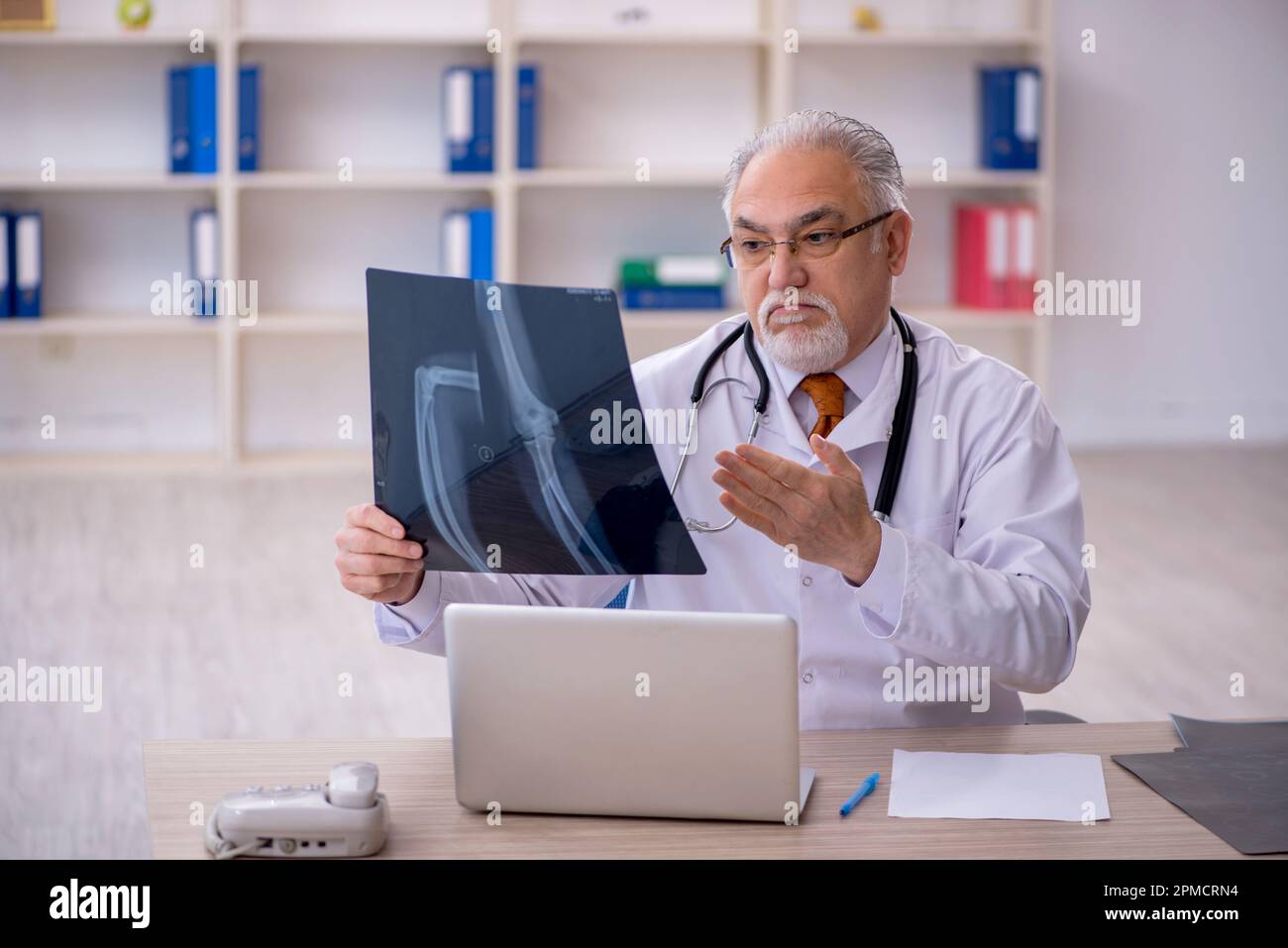 Old doctor radiologist working in the clinic Stock Photo - Alamy
