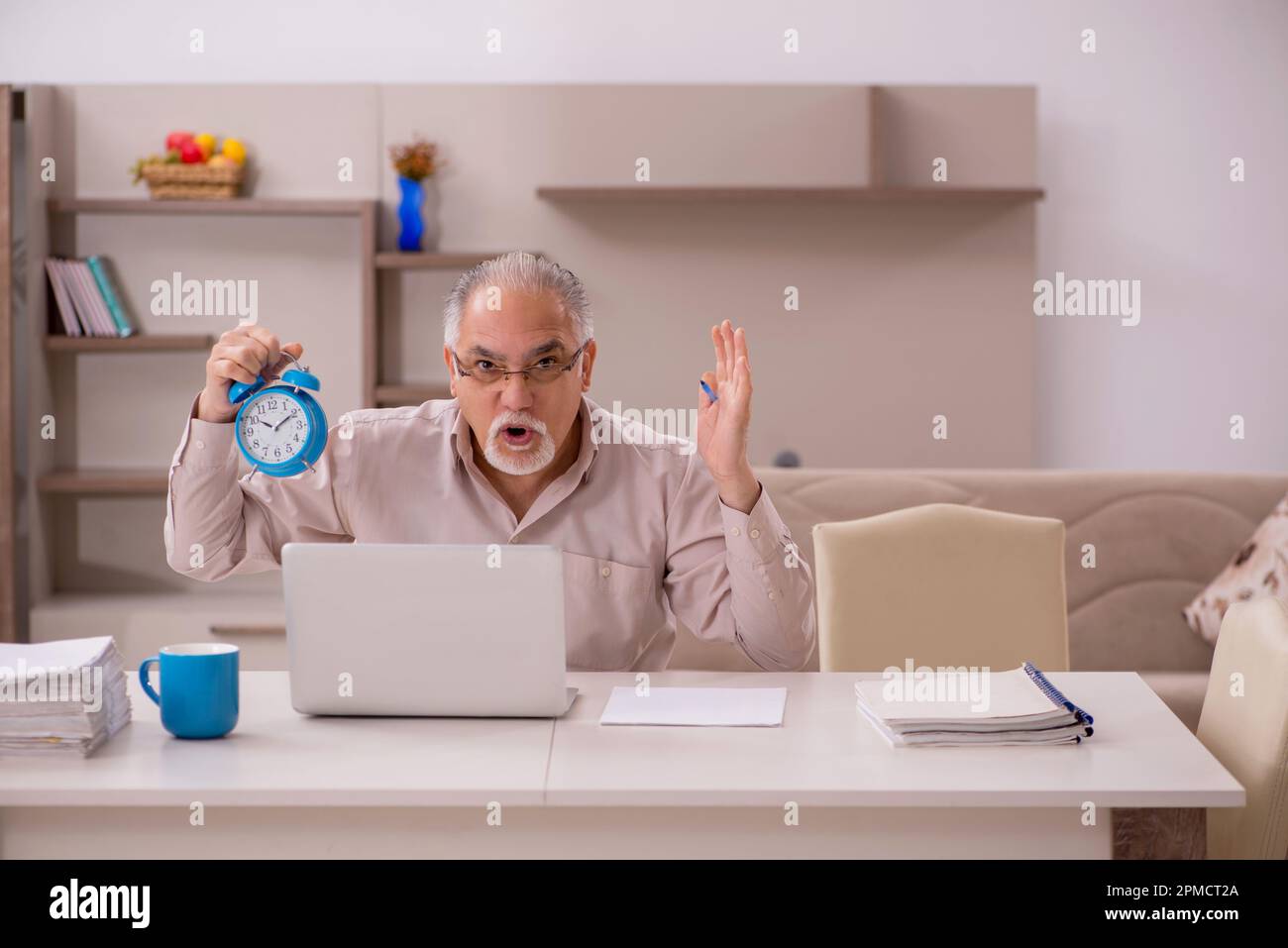 Old boss employee working from home during pandemic Stock Photo - Alamy