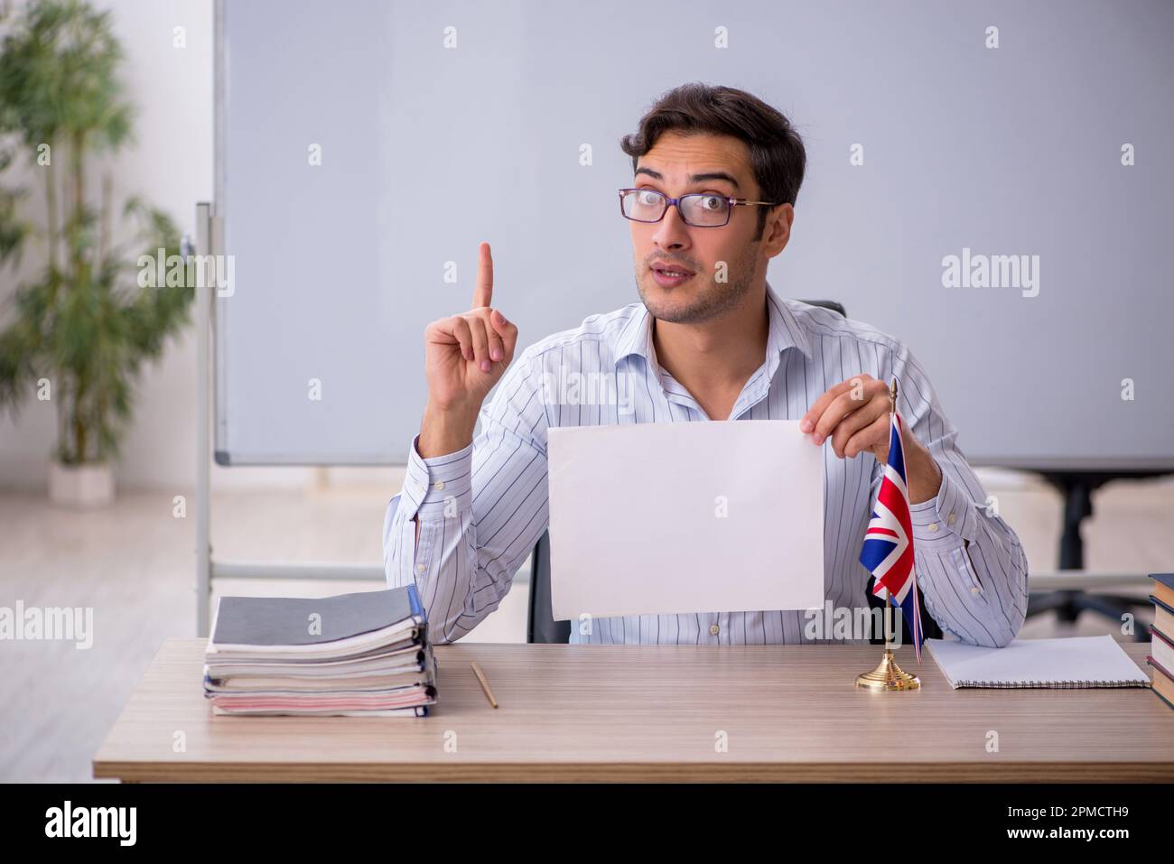 Young english language teacher in the classroom Stock Photo - Alamy