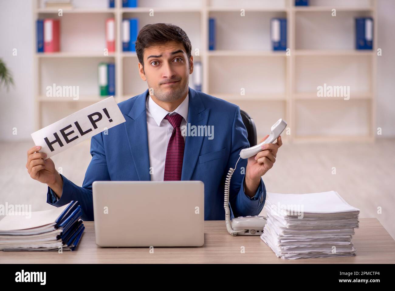Young businessman employee asking for help at workplace Stock Photo - Alamy