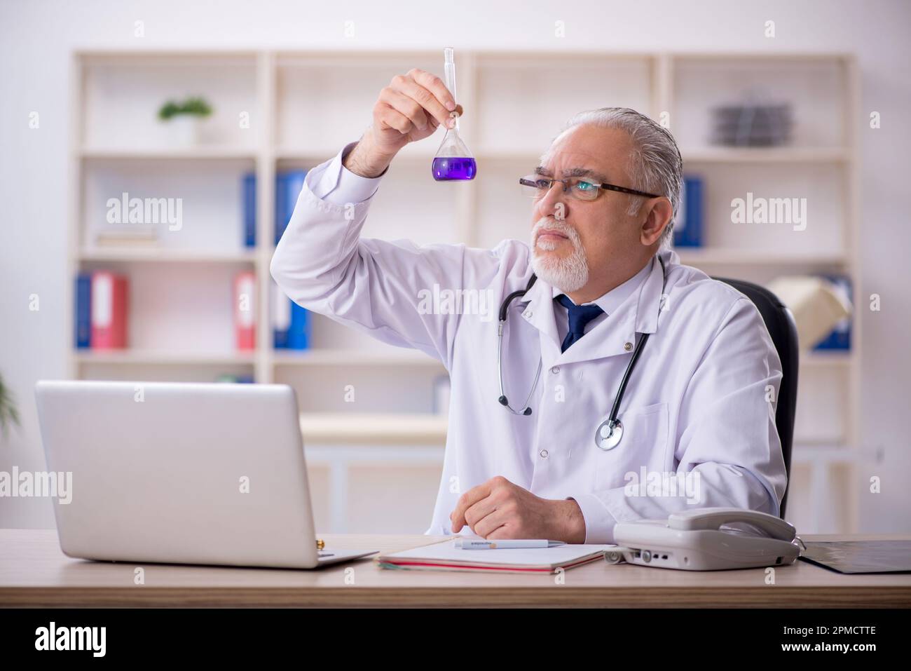Old doctor holding tube at the hospital Stock Photo - Alamy