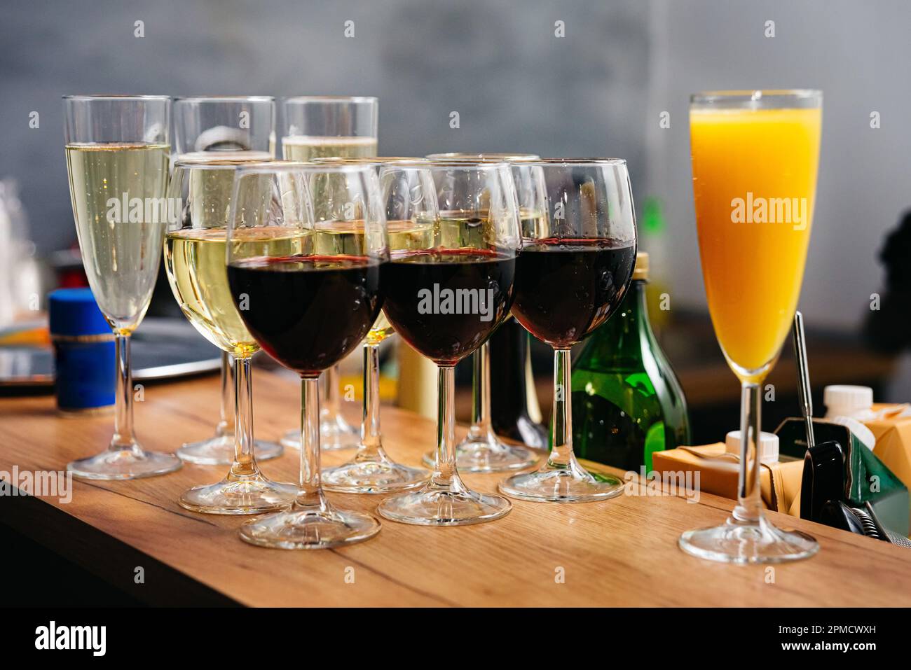 Glasses of red and white wine with orange juice on bar counter ...