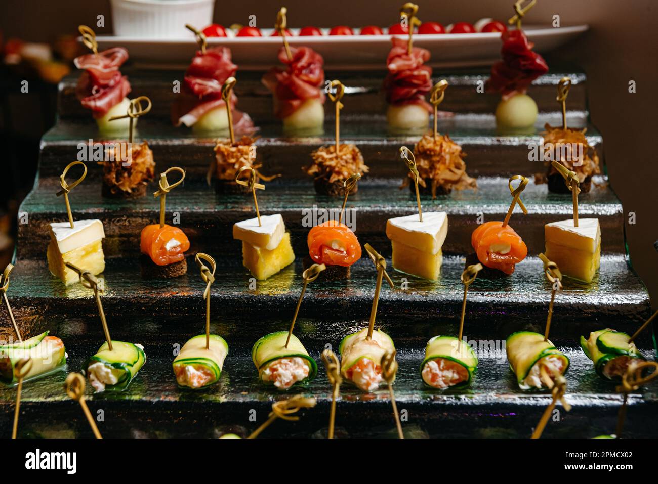 Catering food. Assortments of canapes salmon with cream cheese, melon ...