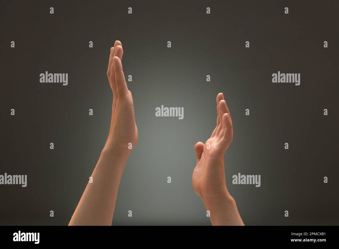 Women's palms up in a dance gesture on the gray background Stock Photo ...