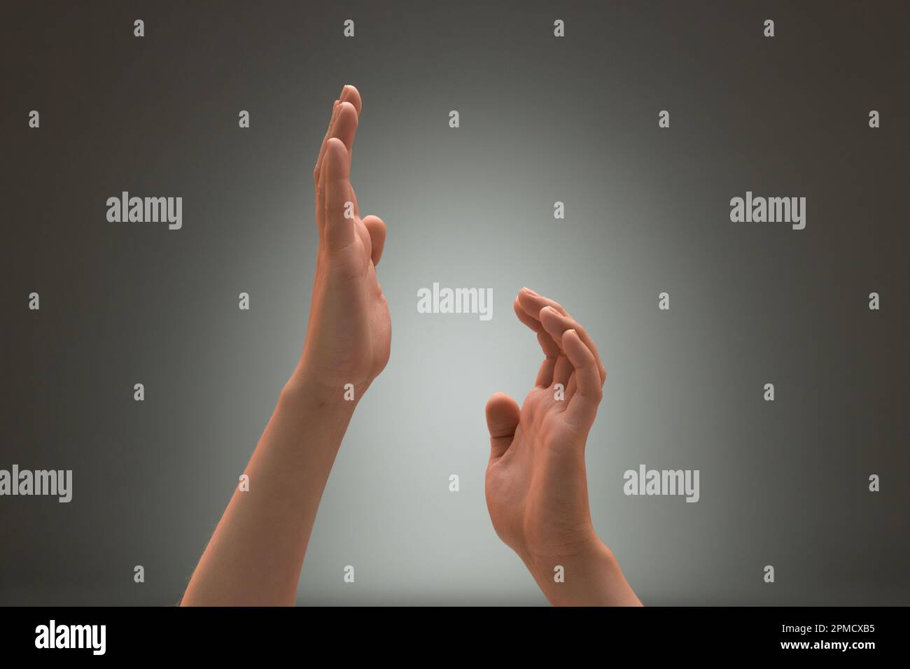 Women's palms up in a dance gesture on the gray background Stock Photo ...