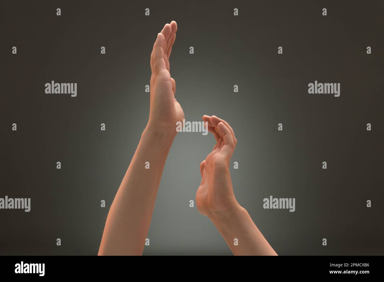 Women's palms up in a dance gesture on the gray background Stock Photo ...
