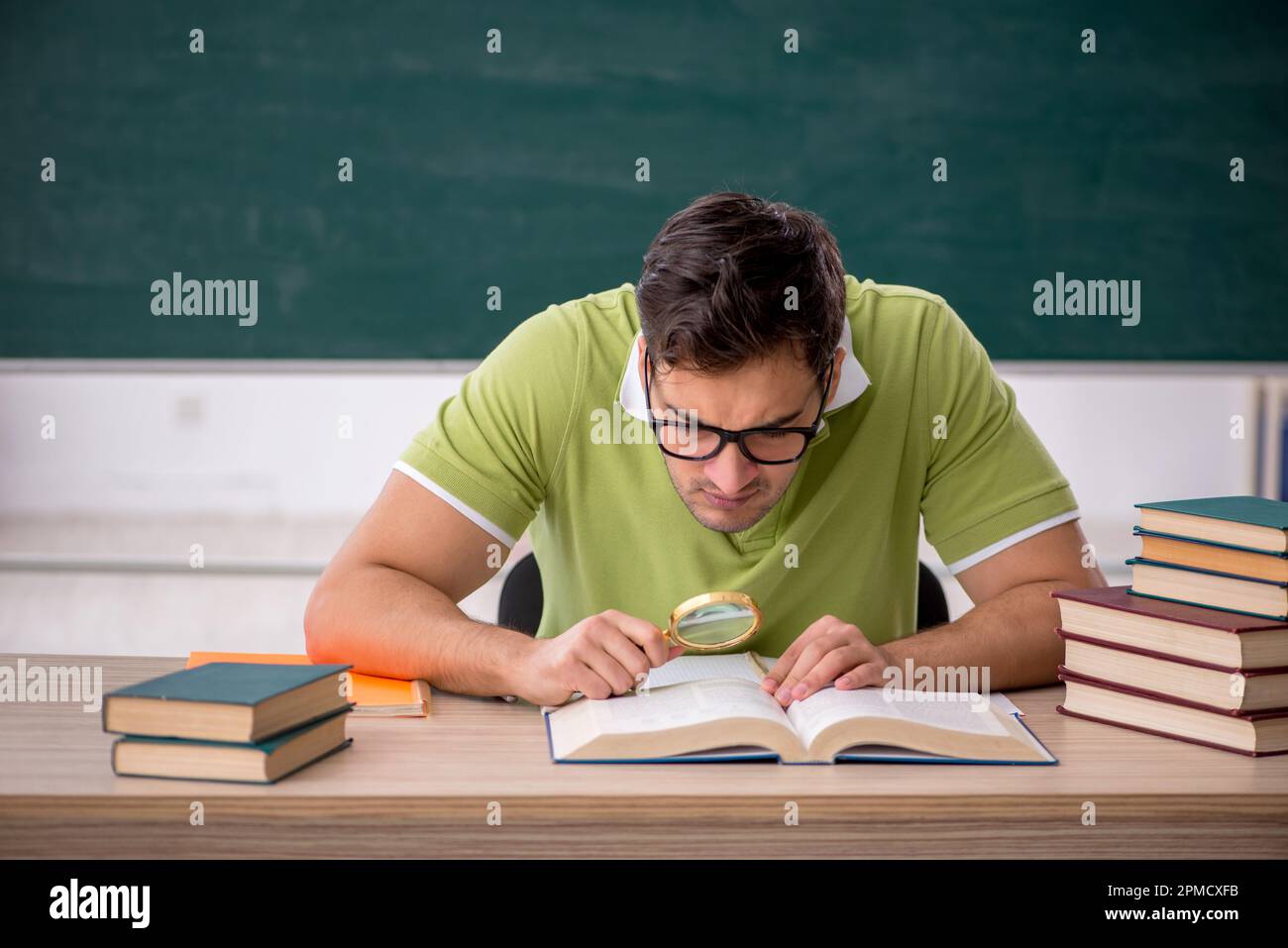 Young student sitting in the classroom in front of blackboard Stock ...