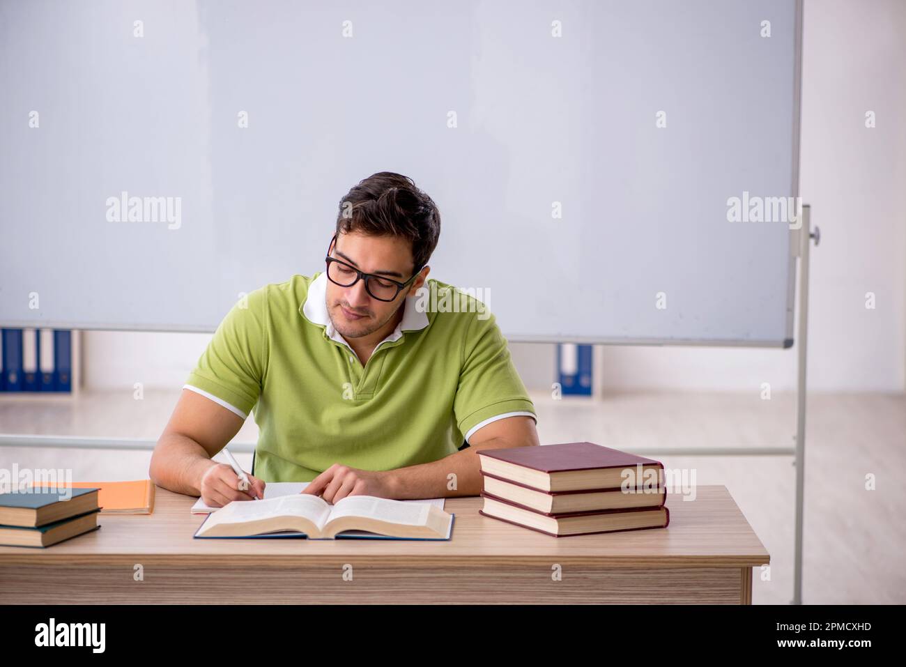 Young student sitting in the classroom in front of whiteboard Stock ...