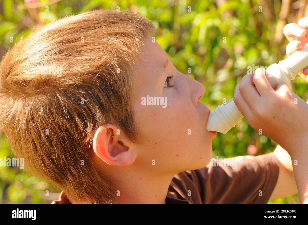 Young boy playing a recorder musical instrument Stock Photo - Alamy