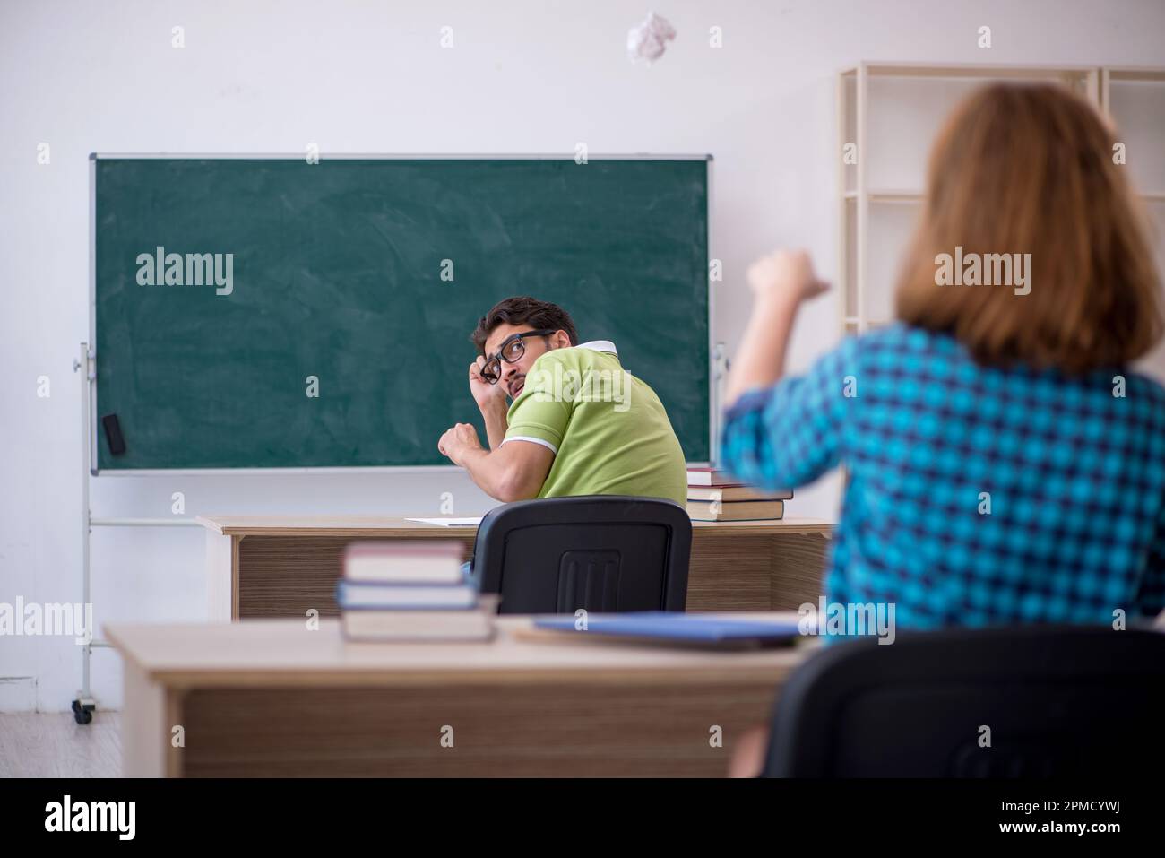 Two students having fun during the lesson Stock Photo - Alamy