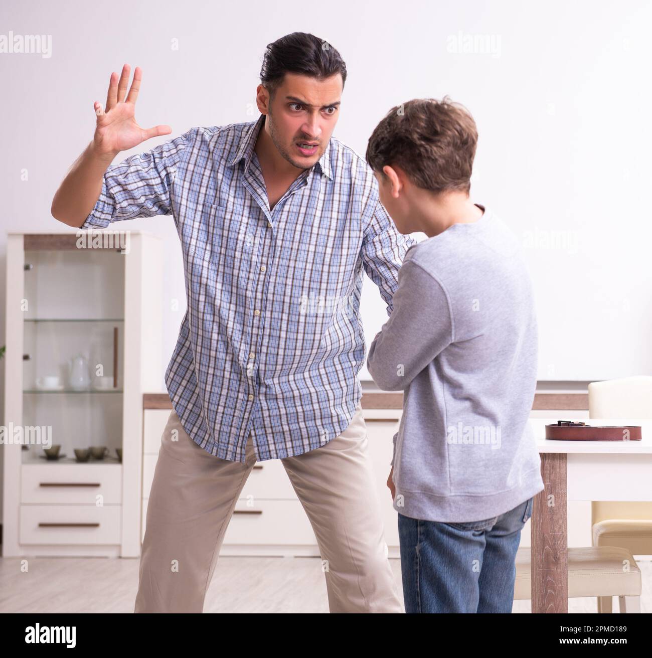 The father beating and punishing his sone Stock Photo - Alamy