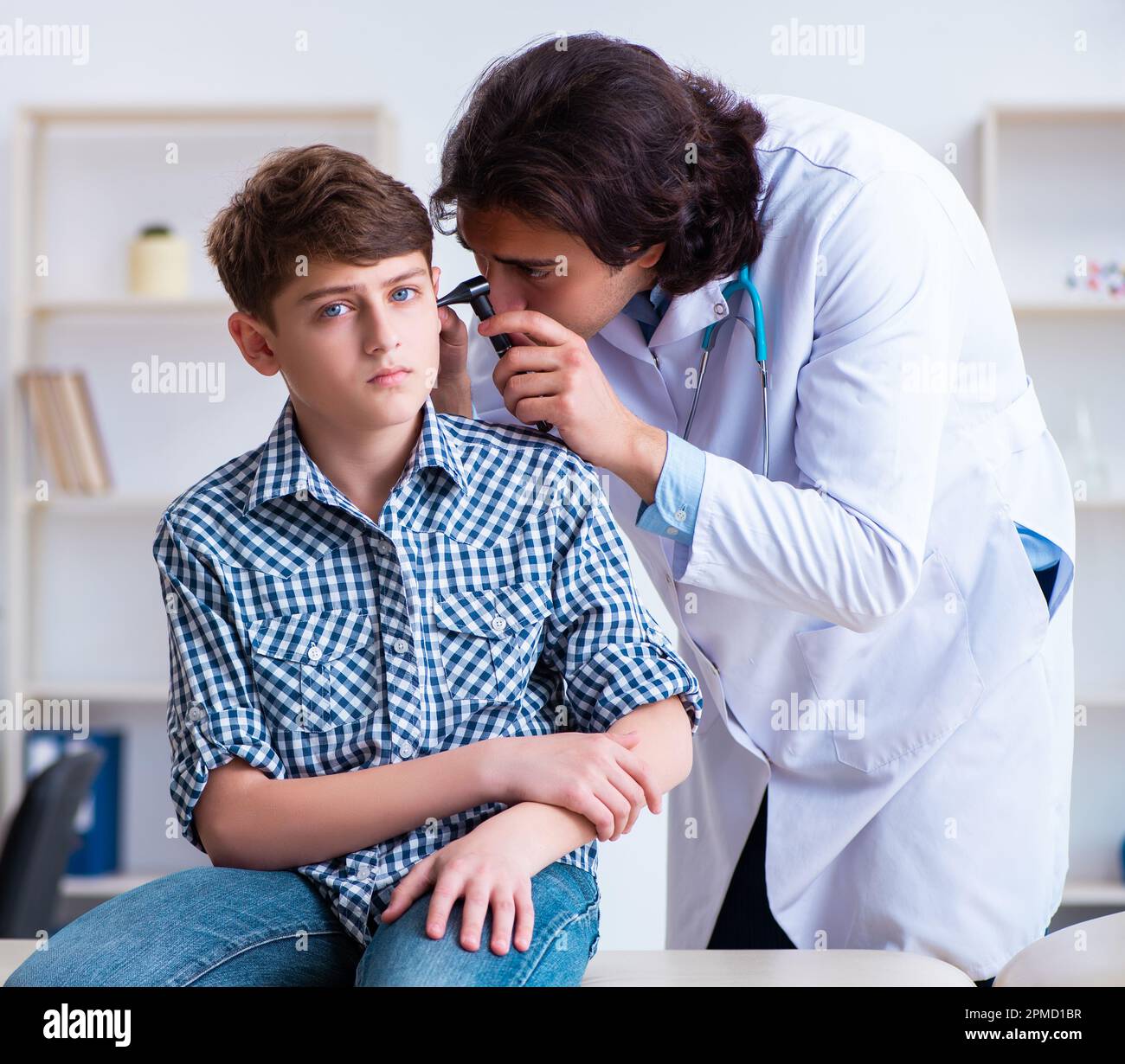 The male otolaryngologist examining boy's ear Stock Photo - Alamy