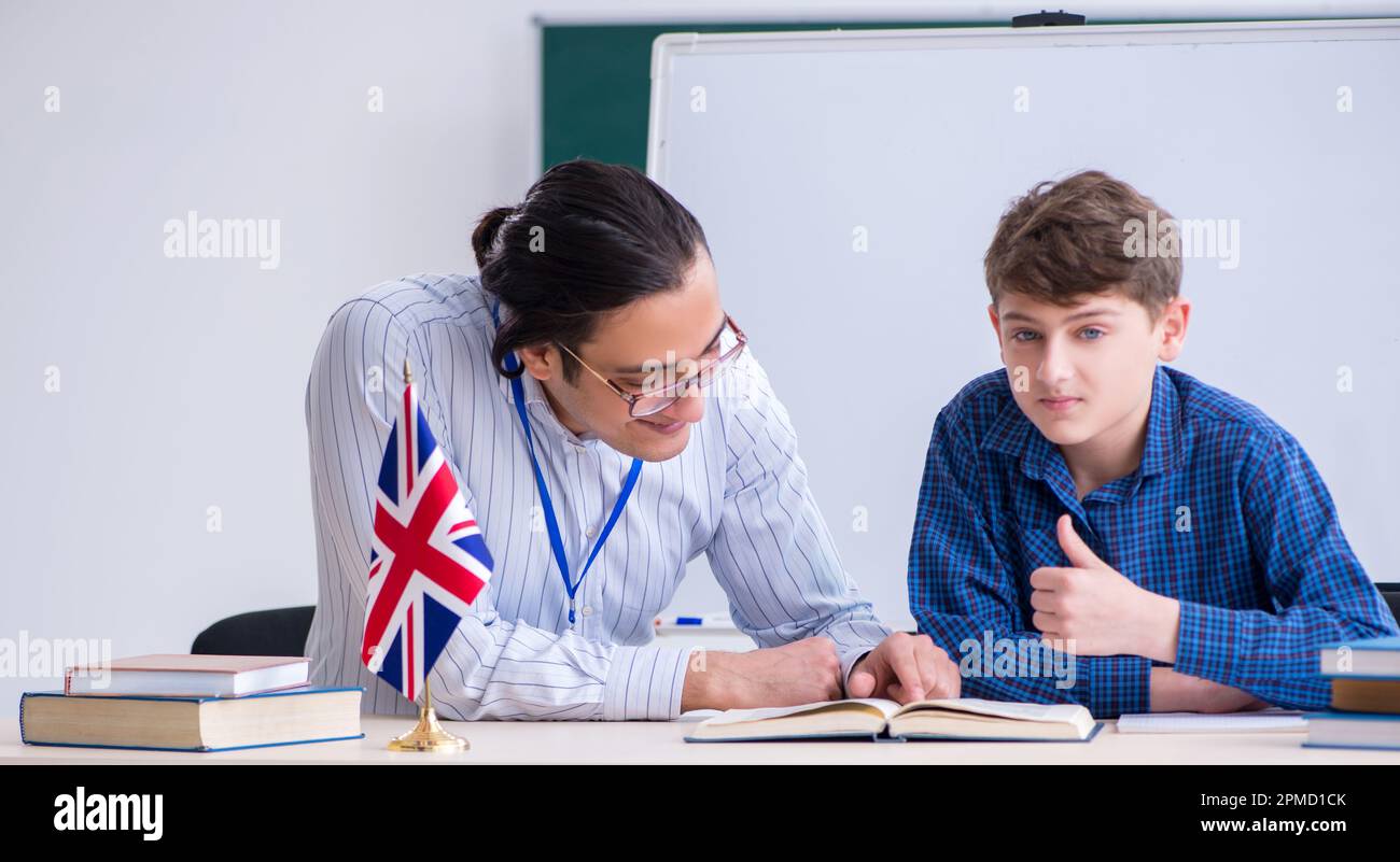 The male english teacher and boy in the classroom Stock Photo - Alamy