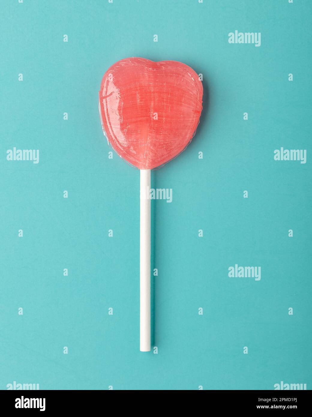 heart shape lollipop on solid background Stock Photo - Alamy