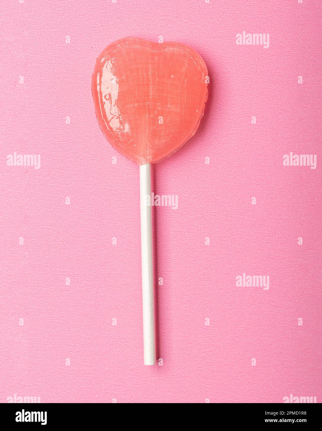 heart shape lollipop on solid background Stock Photo - Alamy