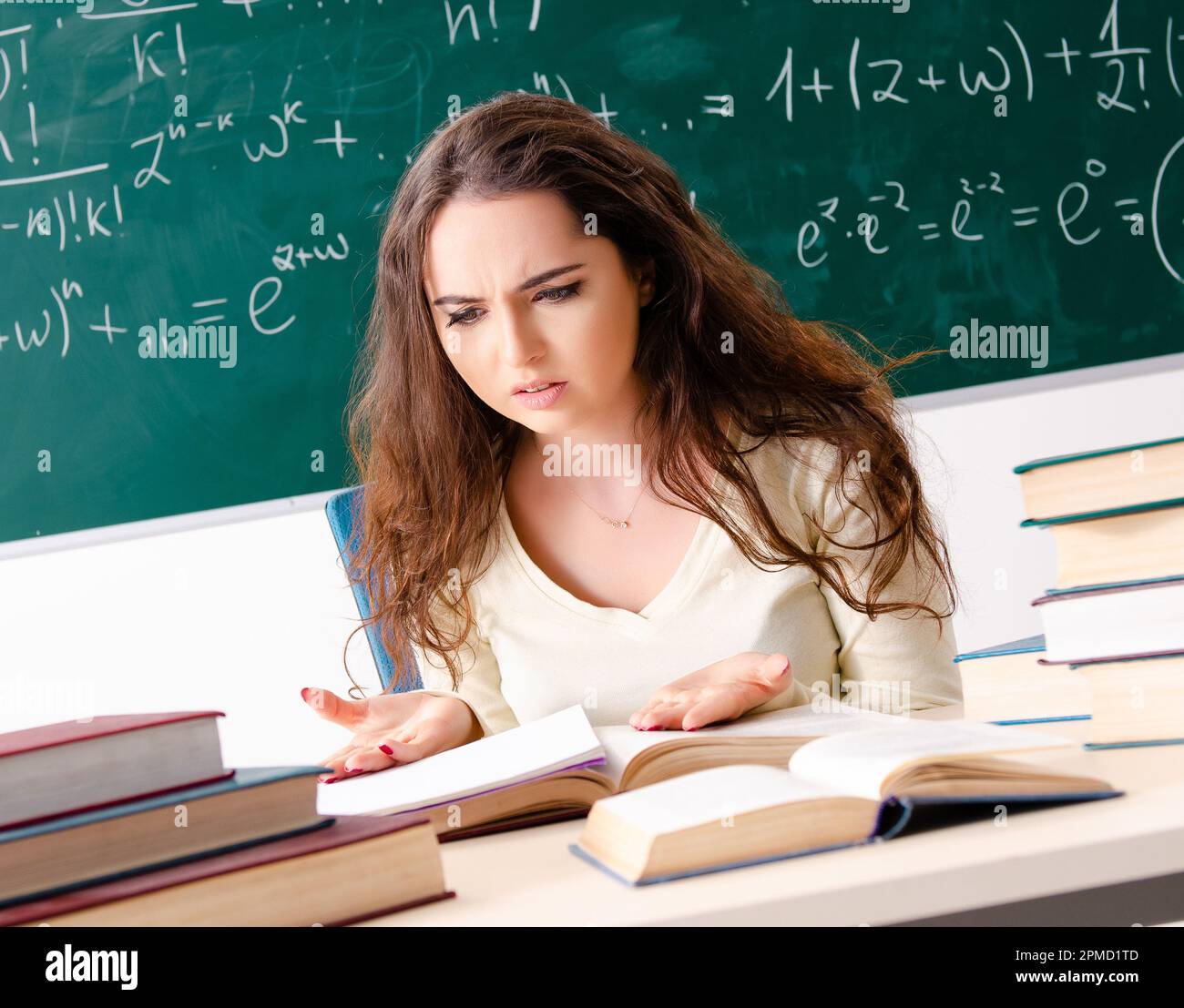 The young female math teacher in front of chalkboard Stock Photo - Alamy