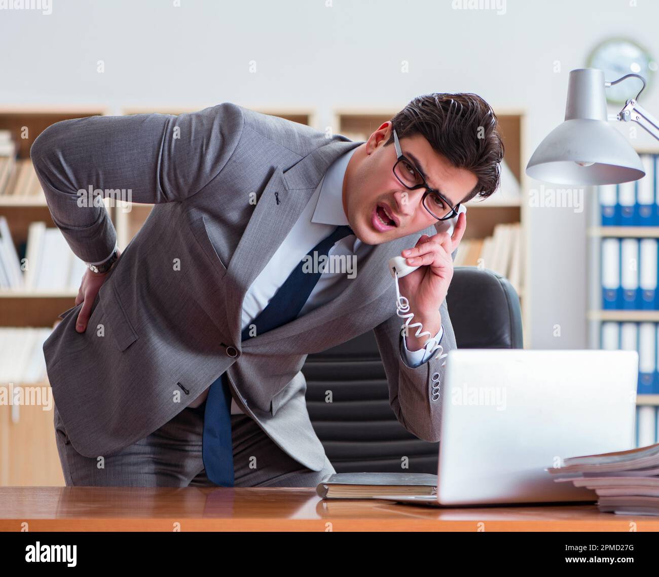 The businessman feeling pain in the office Stock Photo - Alamy