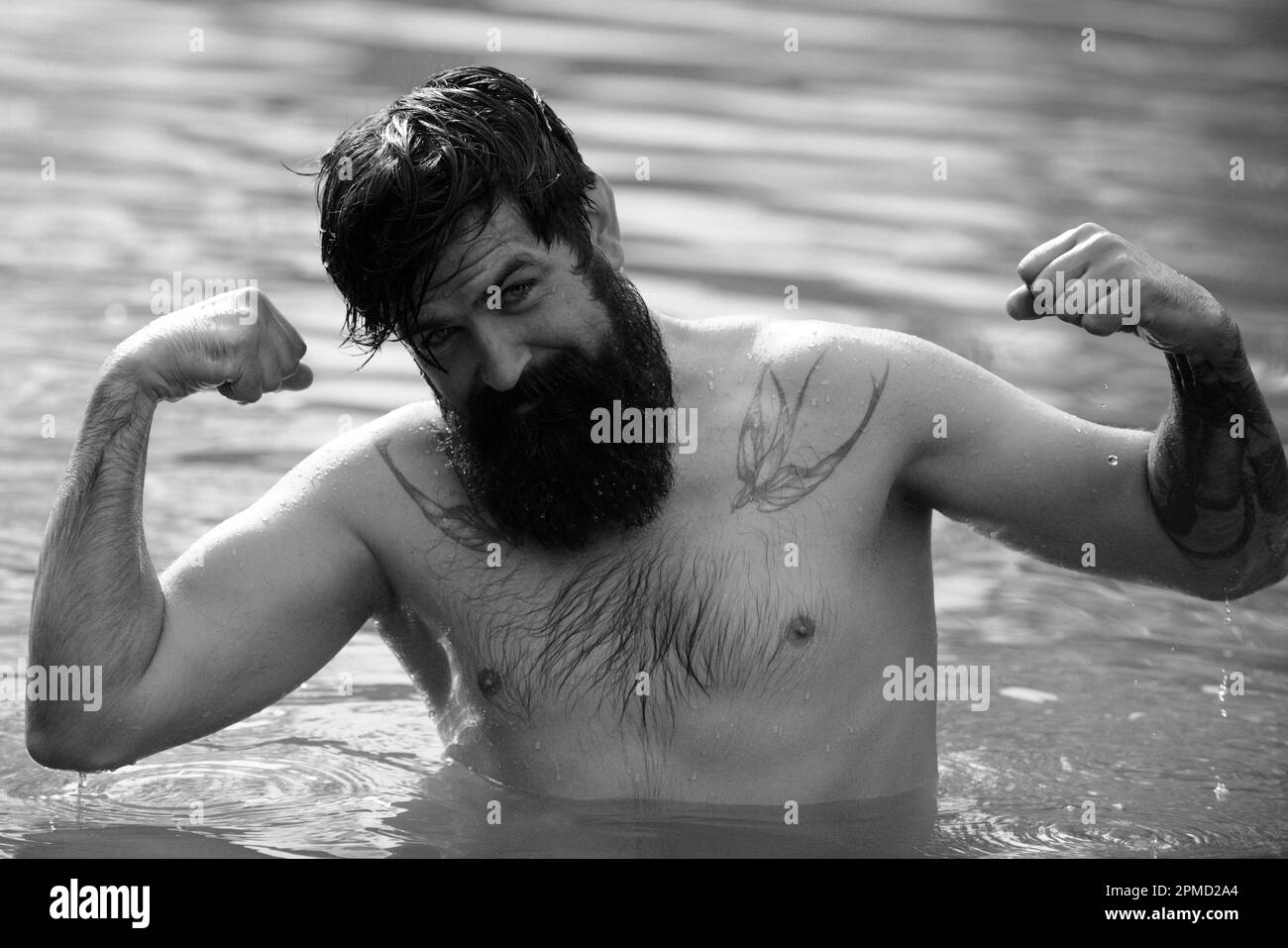 Bearded man on summer holidays. Male swimming in water. Having fun ...