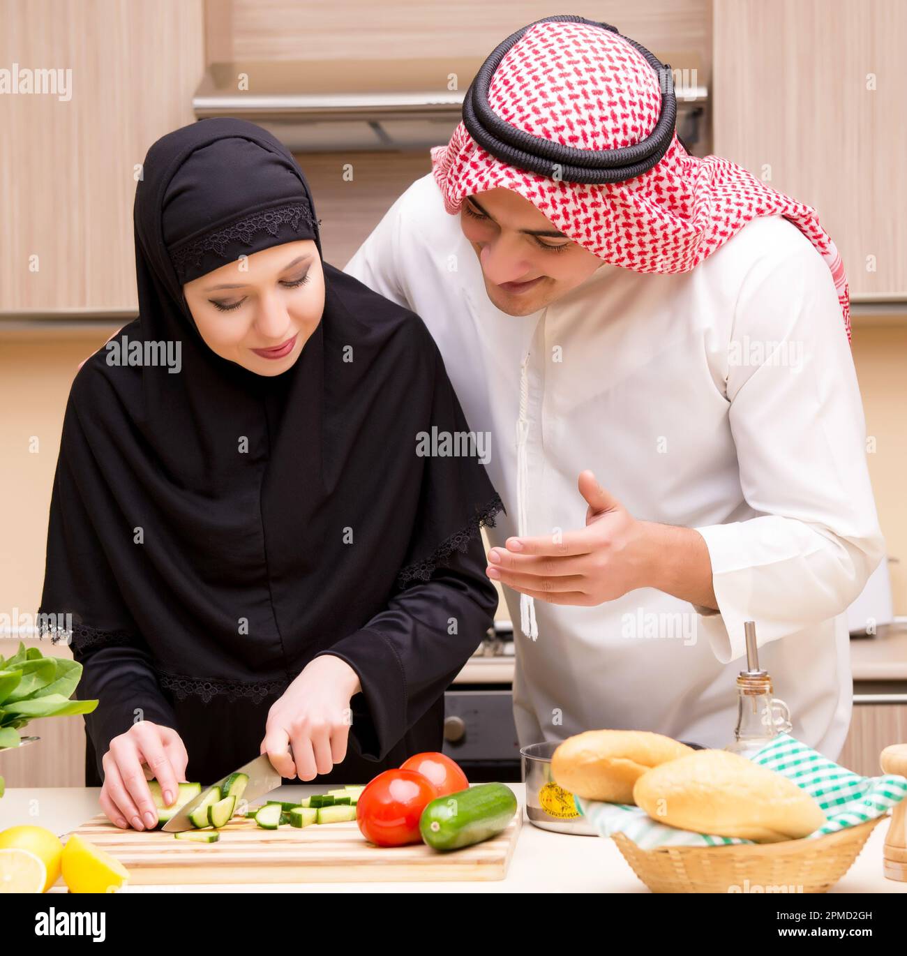 The young arab family in the kitchen Stock Photo - Alamy