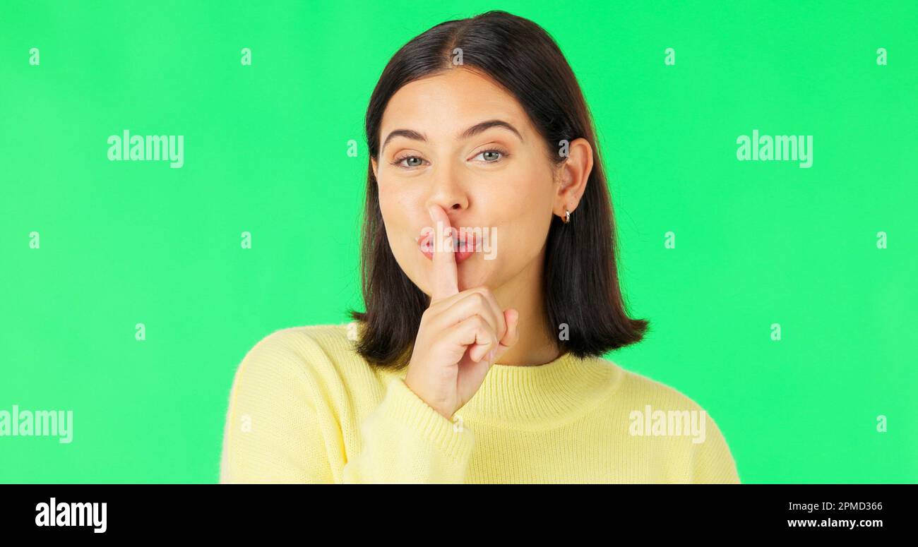 Wink, secret and face of a woman on a green screen isolated on a studio ...