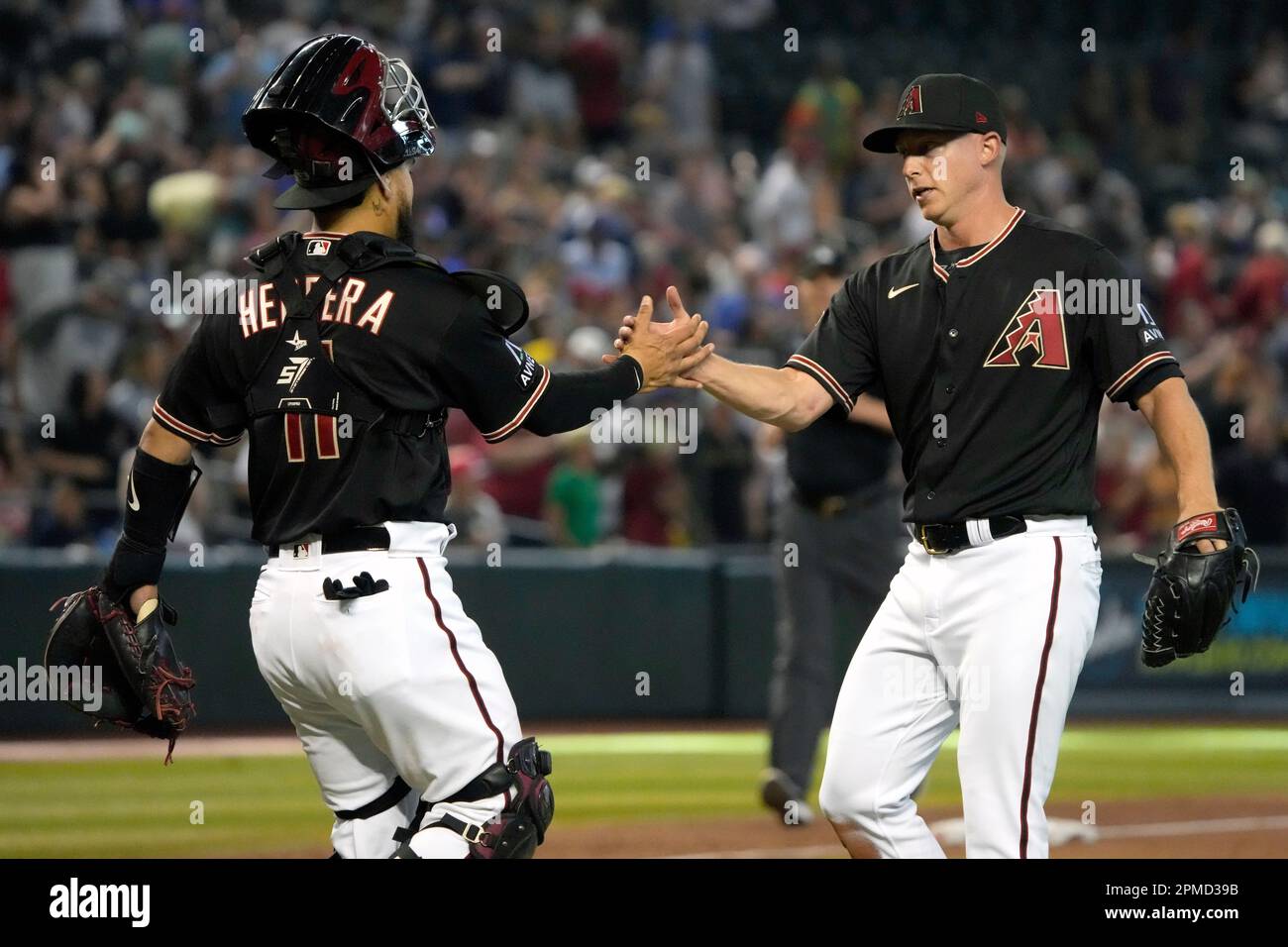 Arizona Diamondbacks catcher Jose Herrera (11) and pitcher Scott ...