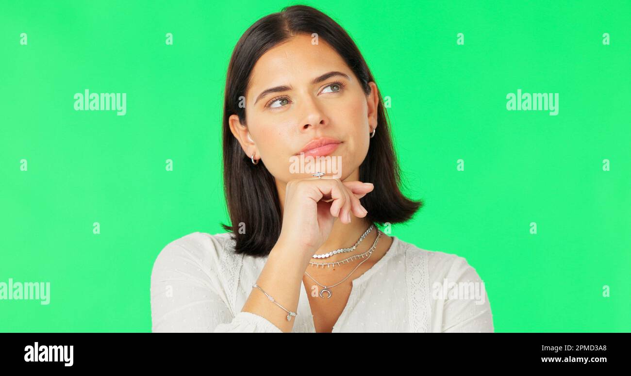 Face, idea and decision with a woman on a green screen background in ...