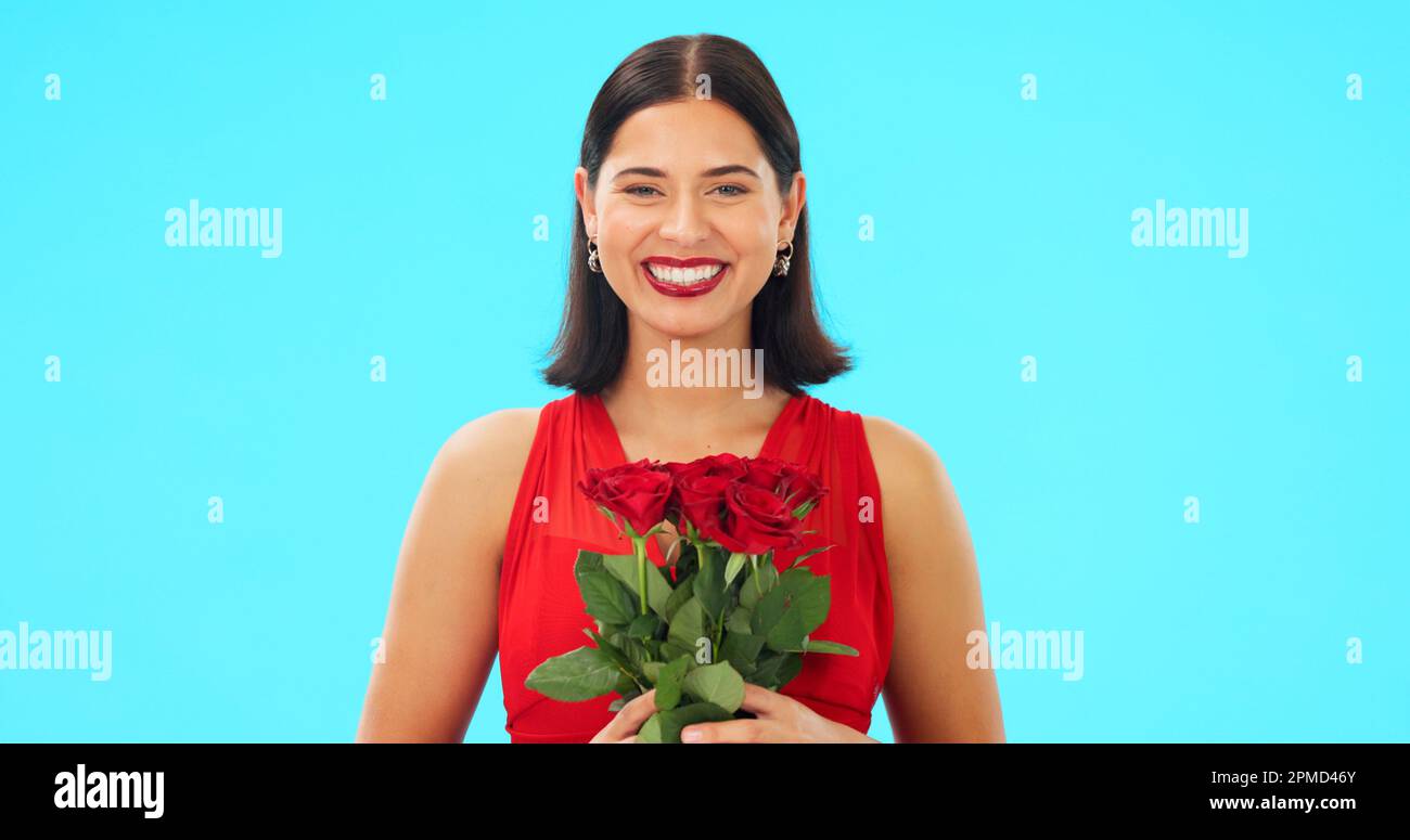 Rose flowers, face and happy woman in studio, blue background and color ...