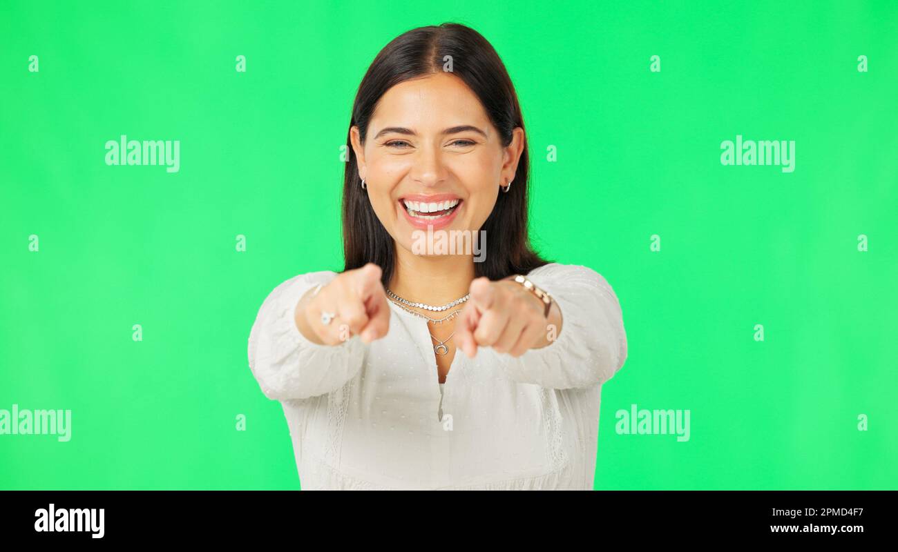 Face, pointing to you and woman with green screen, motivation and happiness on studio background ...