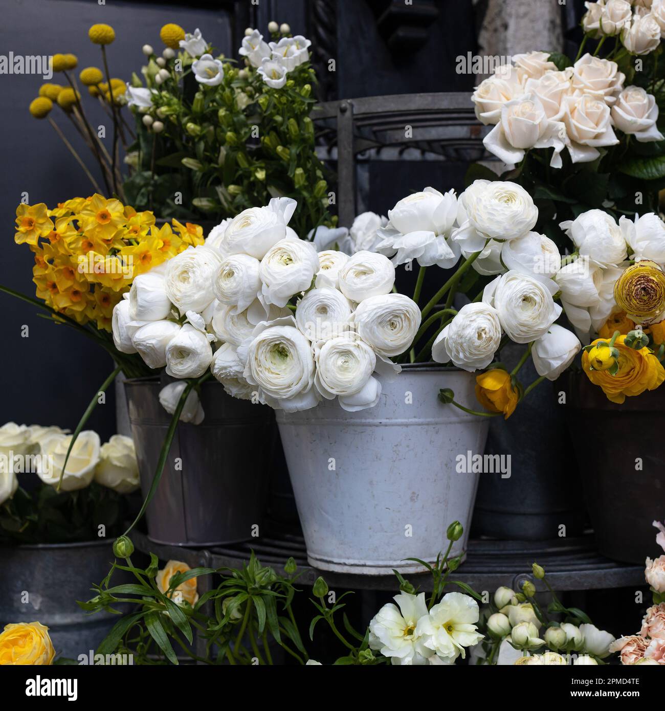 Large armfuls of pink roses, yellow and white ranunculus, bluebell ...