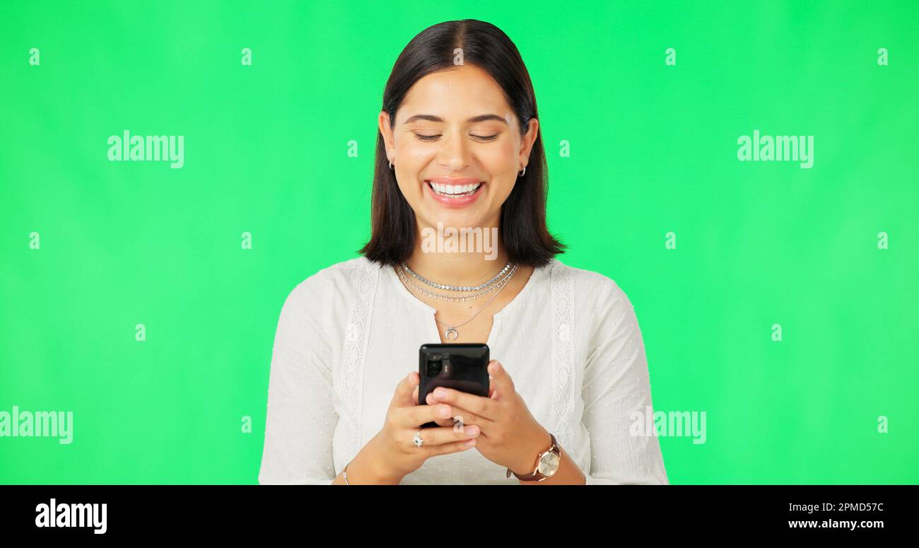 Happy woman, smartphone and typing on green screen, studio and social ...