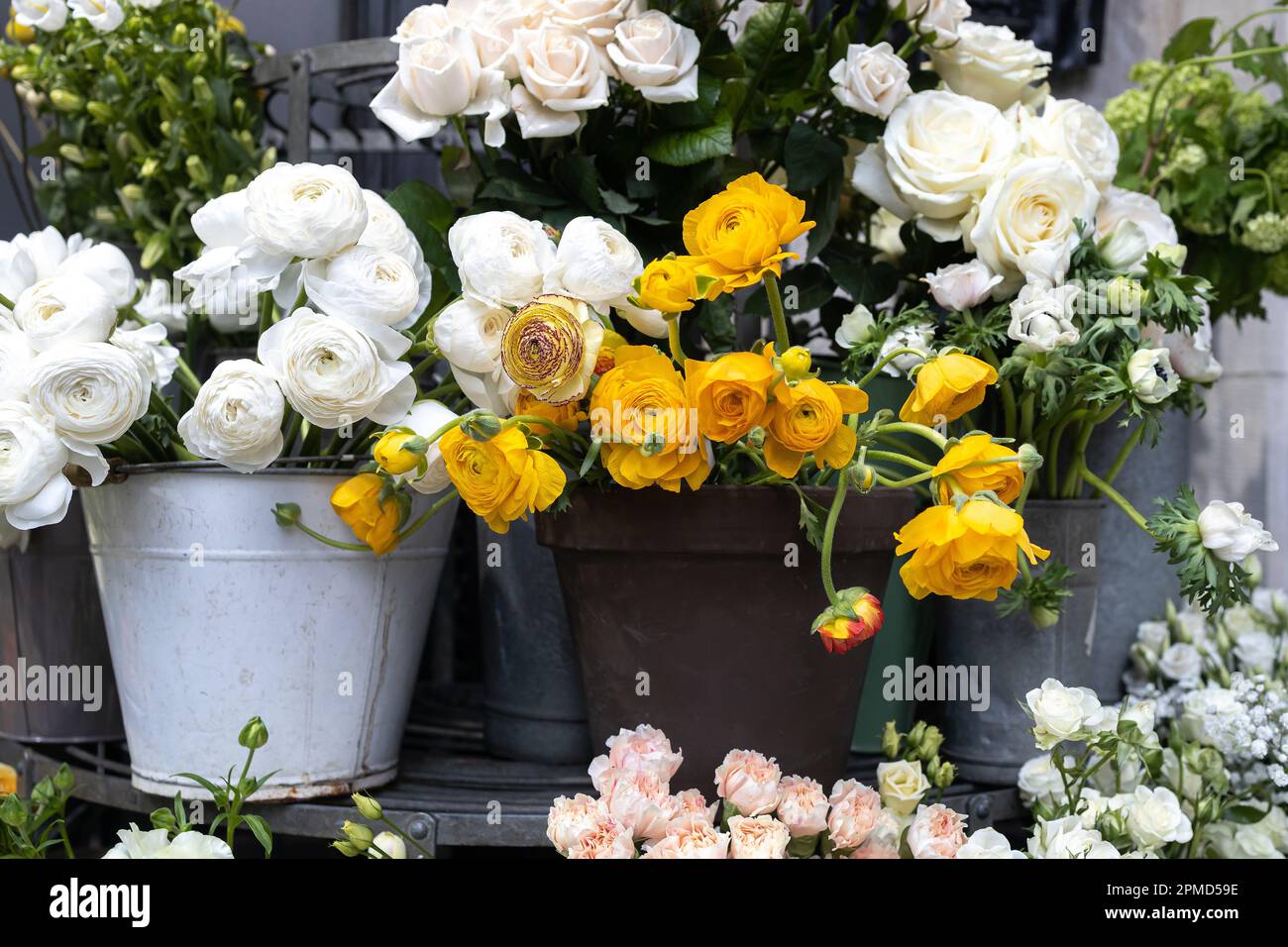 Large armfuls of pink roses, yellow and white ranunculus, bluebell ...