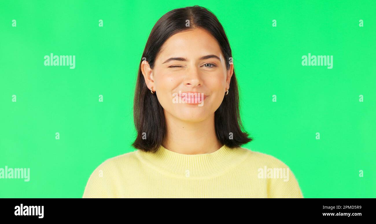 Happy, woman and face wink on green screen, studio and color background ...