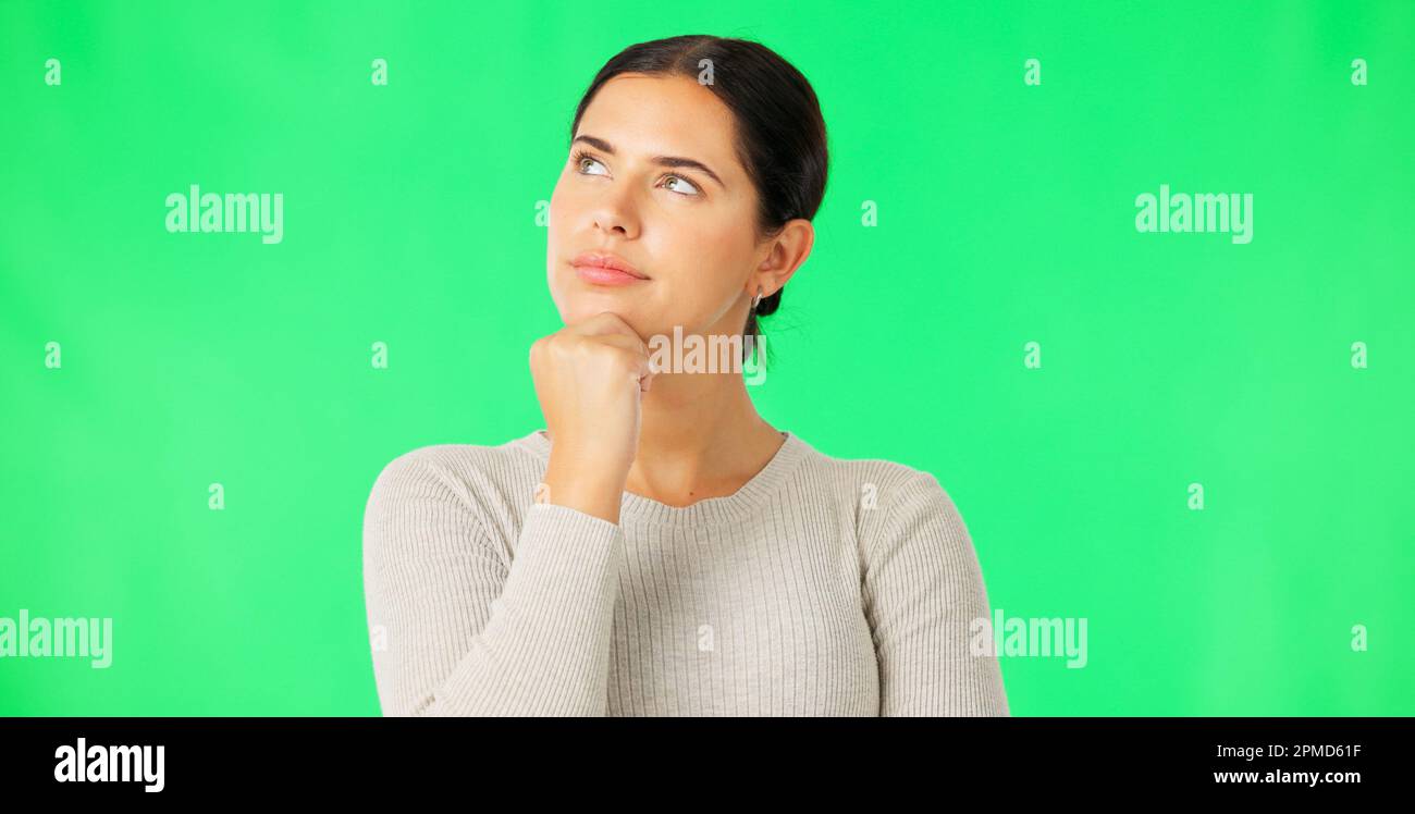 Face, thinking and option with a woman on a green screen background in ...
