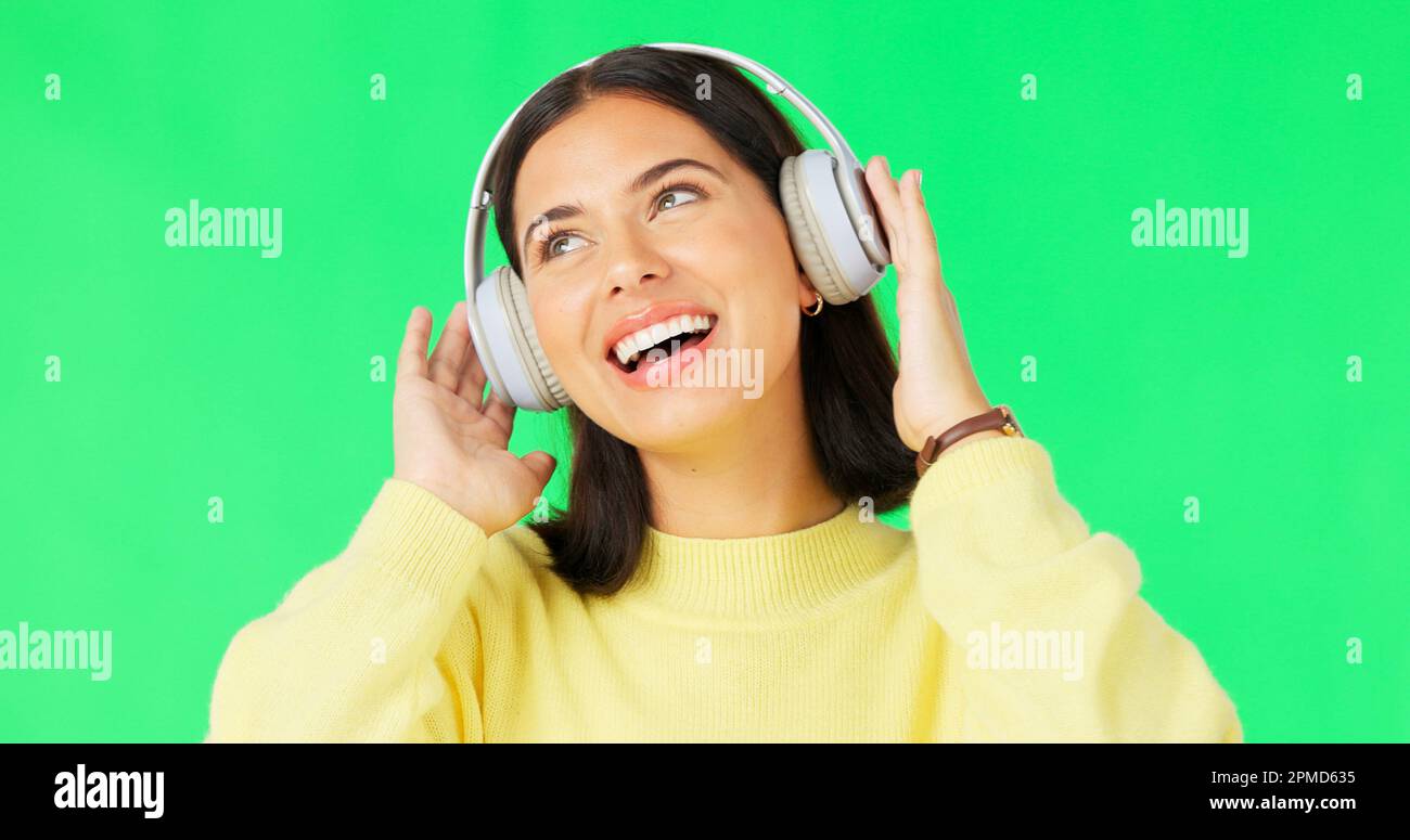 Face, green screen and woman with headphones, dance and music streaming ...