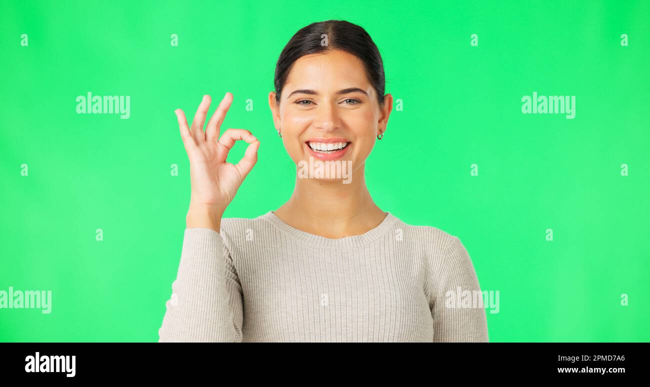 Okay hands, face and woman smile on green screen, background and studio ...
