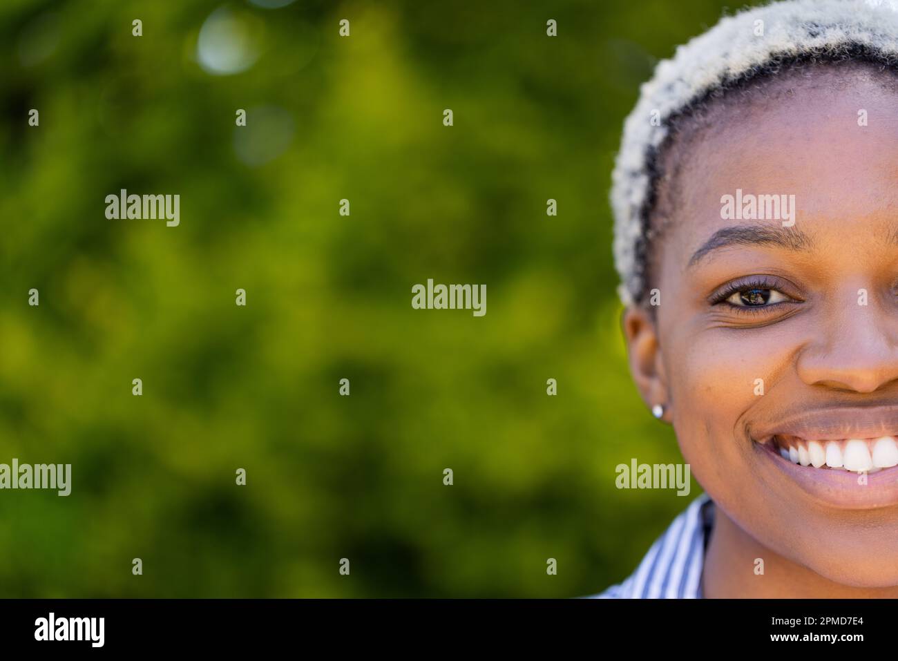 Cropped face of african american young woman with short hair smiling ...