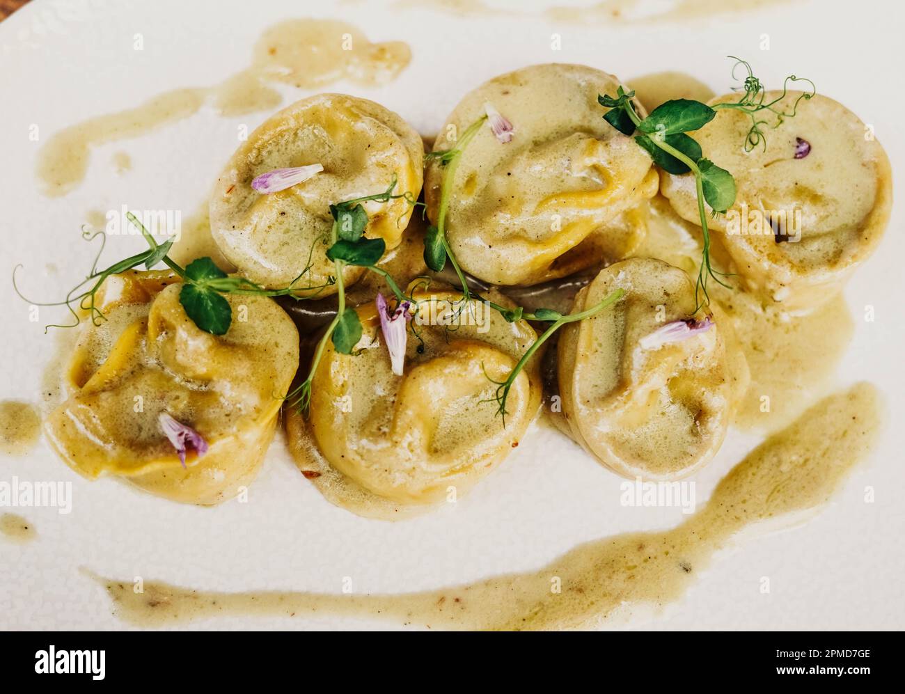 In this photo, we see a plate of homemade Italian pasta with a ...