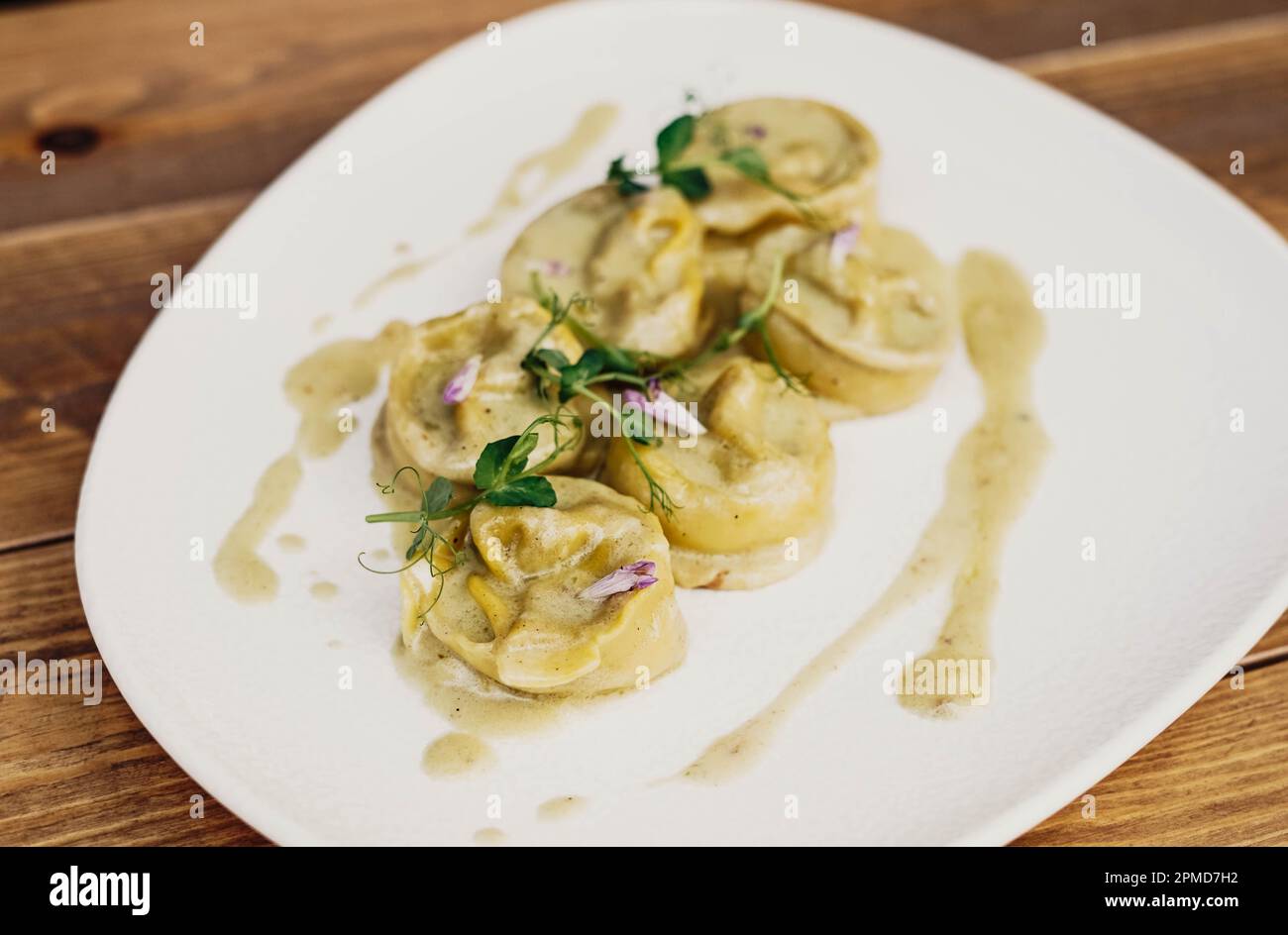 In this photo, we see a plate of homemade Italian pasta with a ...