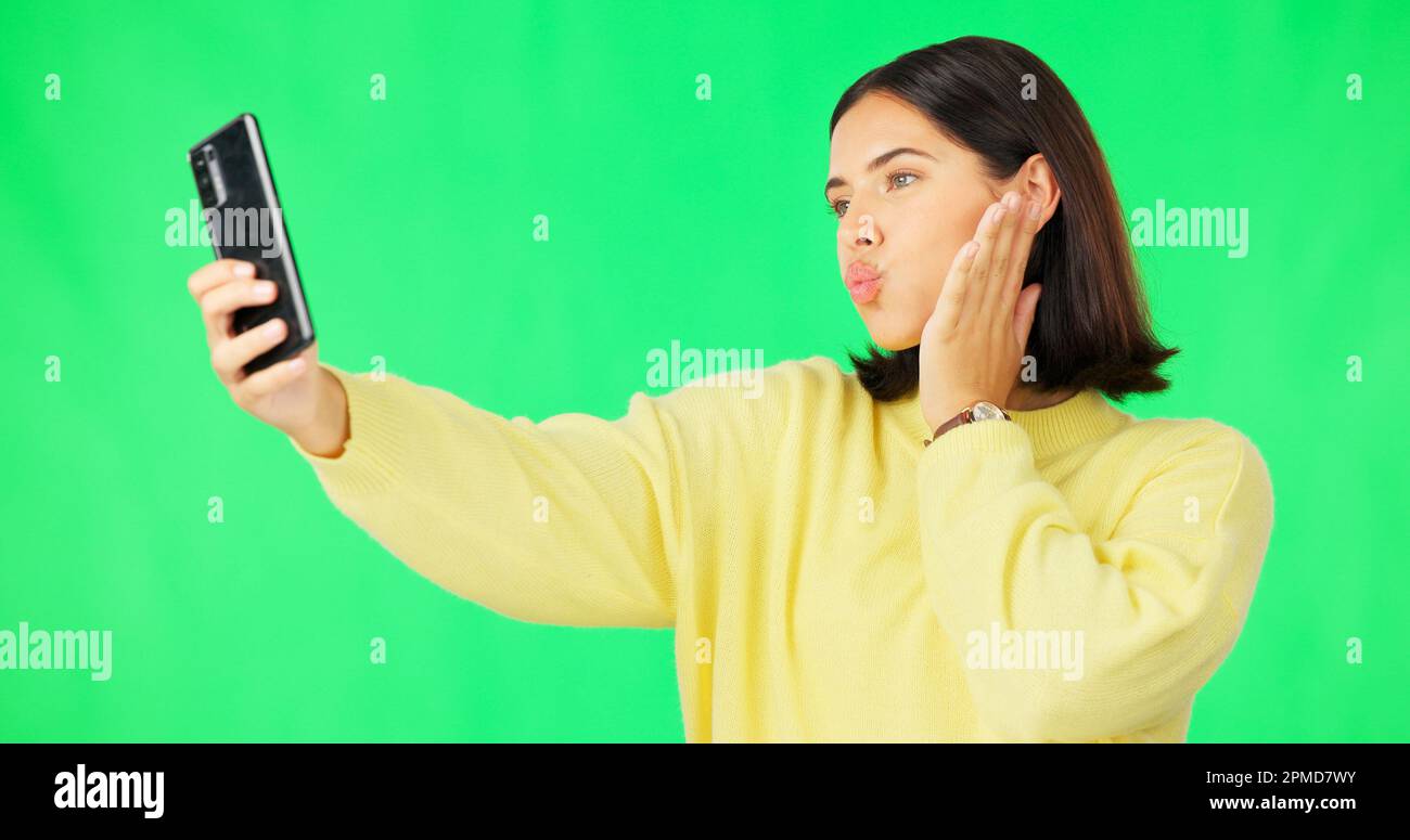 Happy woman, face and selfie on green screen with peace sign and facial expressions against ...