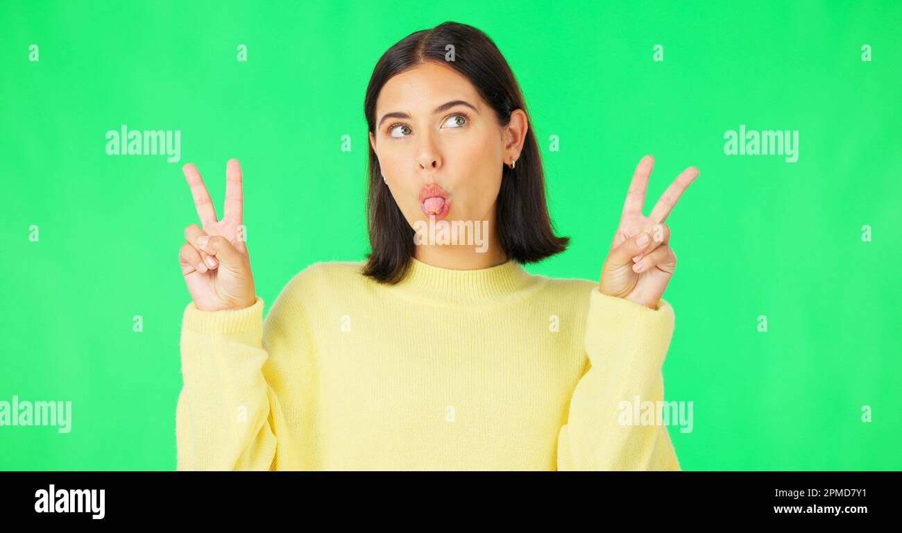Green screen, funny face expression and happy woman posing with tongue ...