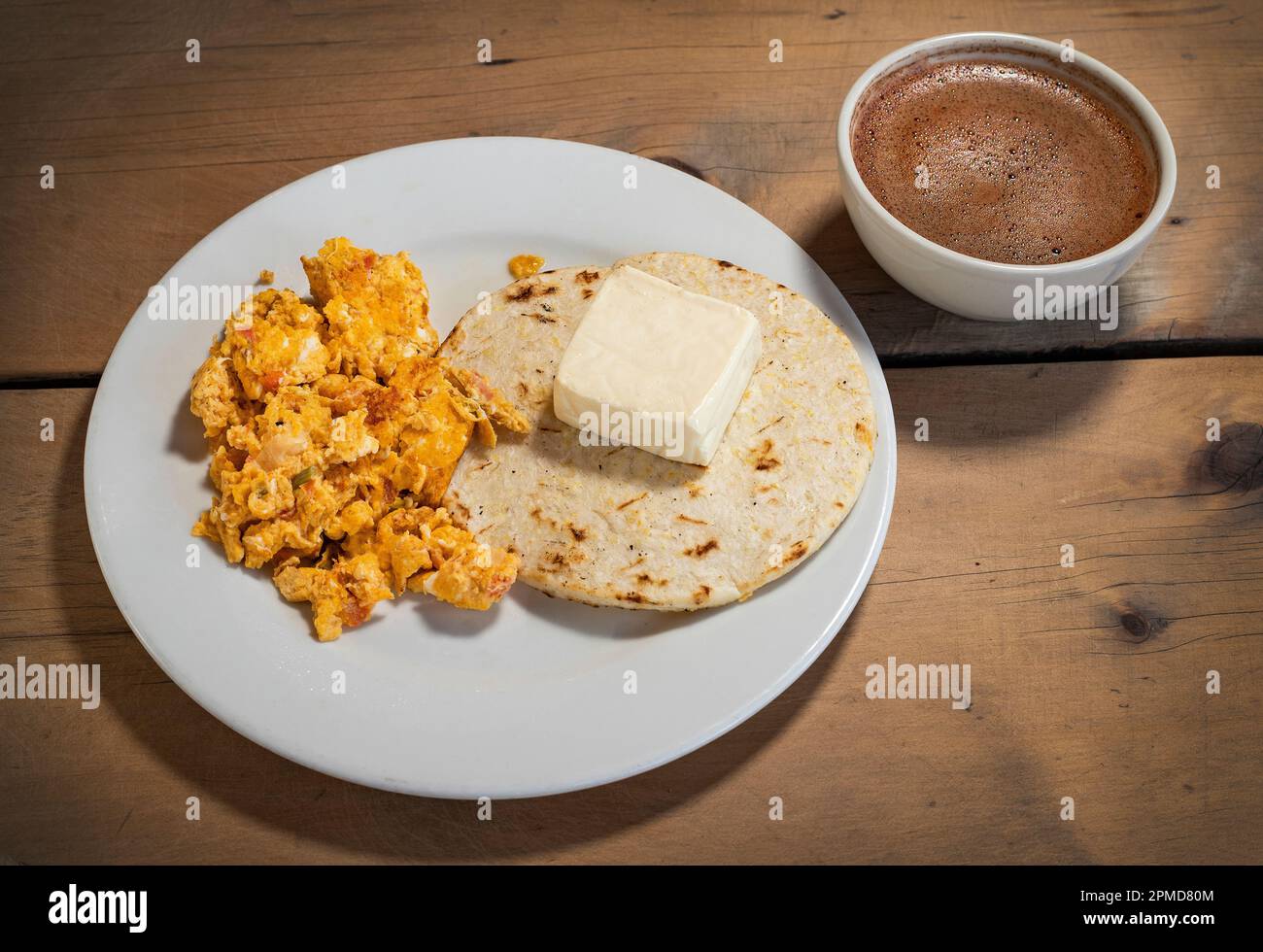 Traditional Colombian breakfast - Arepa with cheese, egg and hot ...